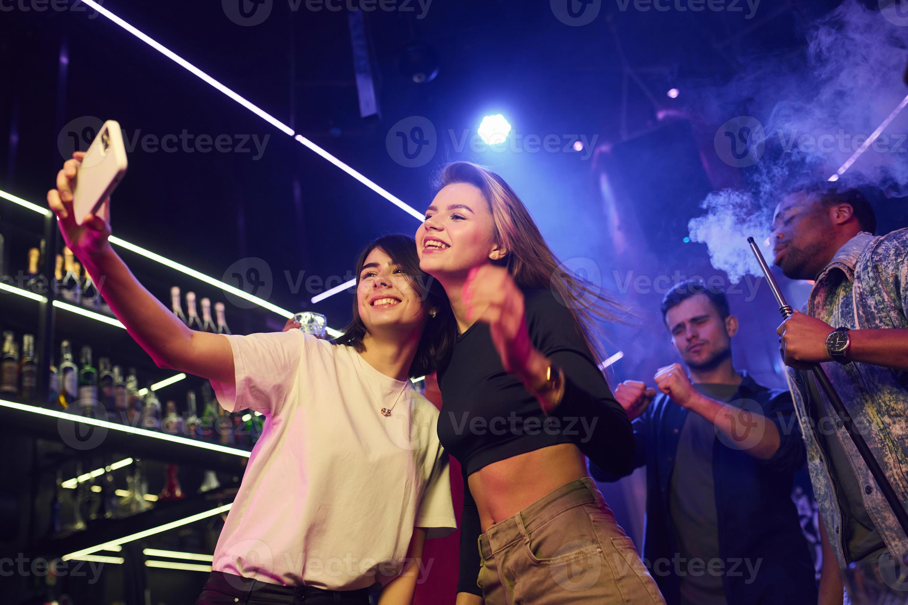 Two Women Making Selfie Group Of Friends Having Fun In The Night Club