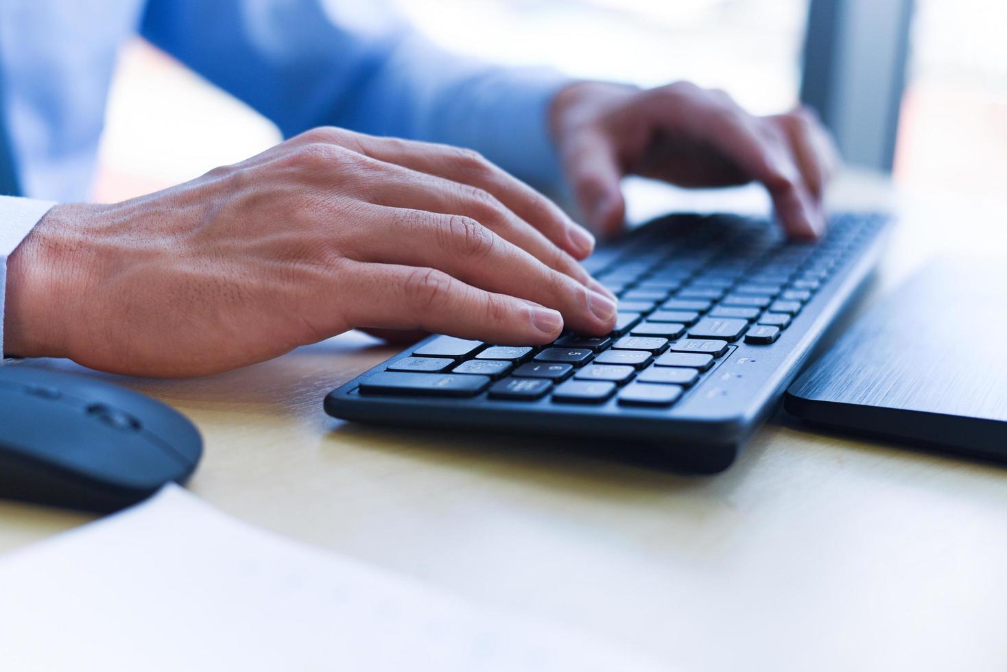 Close up of typing male hand on keyboard concept - Businessman working on keyboard and mouse ...