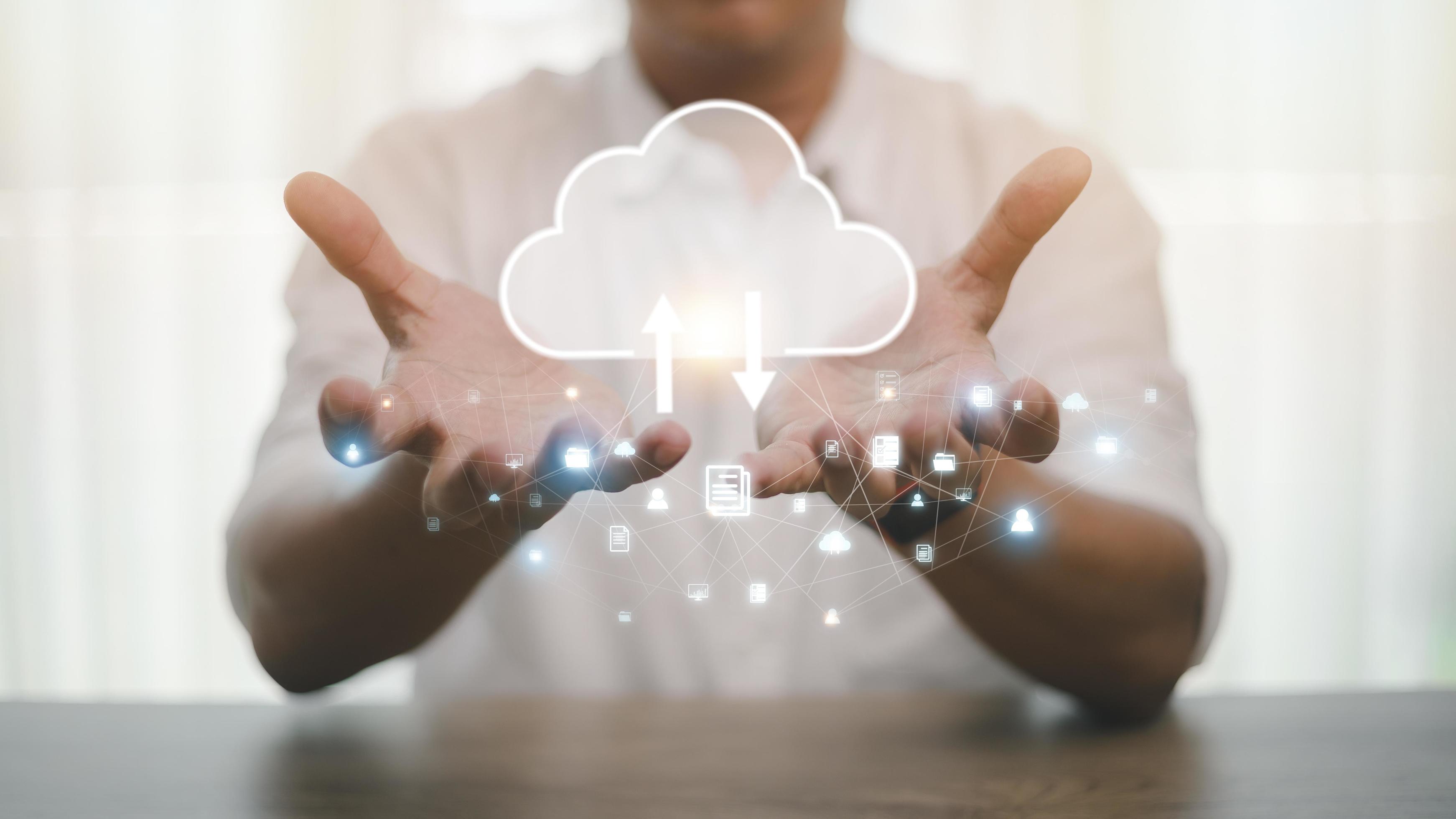 Hand holding virtual cloud computing with world and technology item such as upload download ...