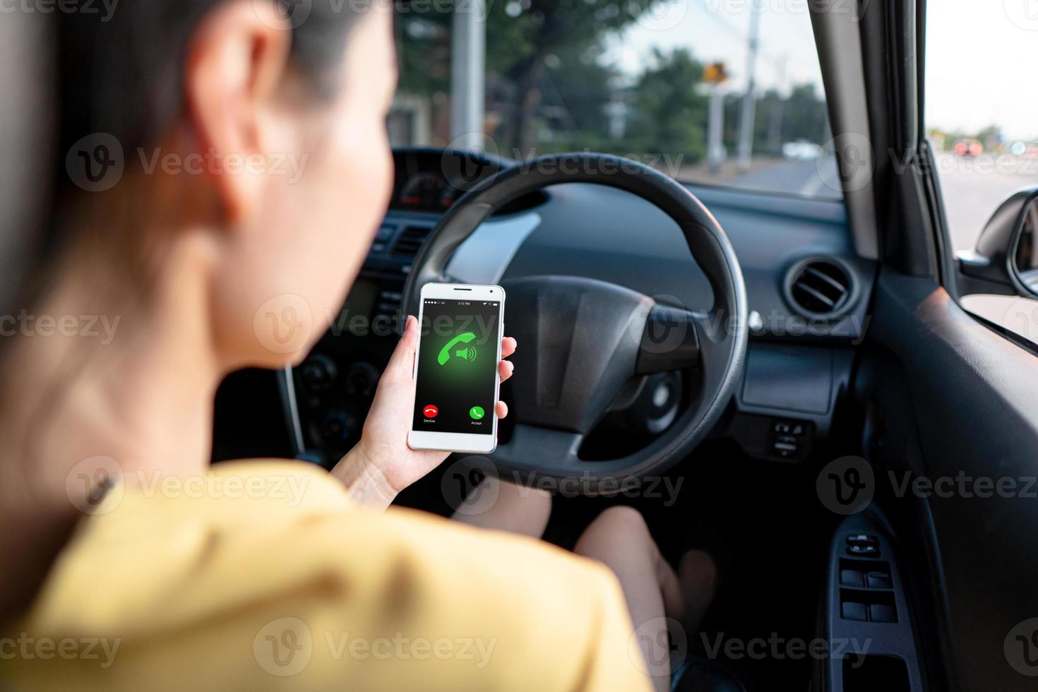 Close-up of woman talking on mobile phone while driving a car. 8727692 ...