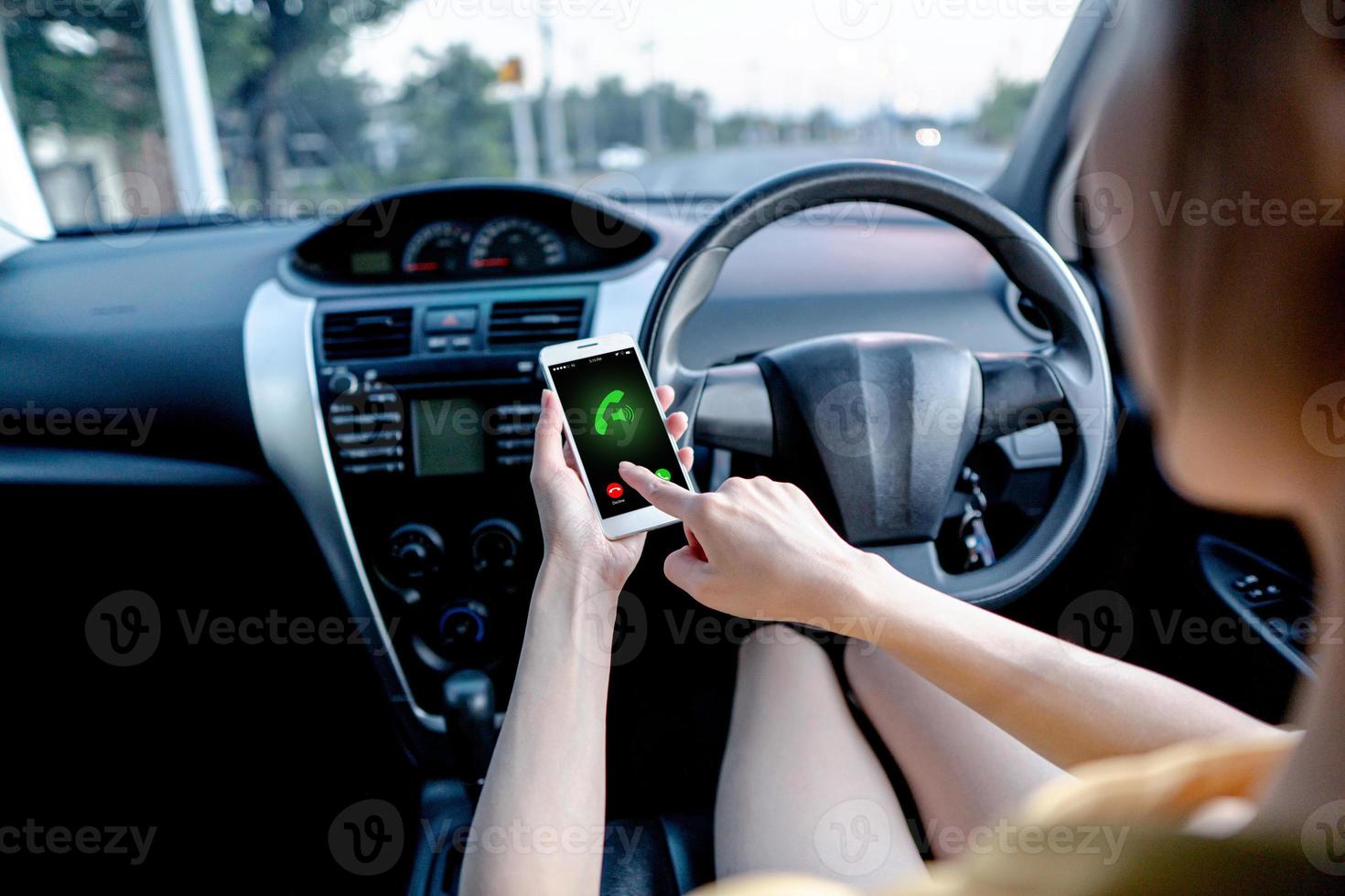 Close-up of woman talking on mobile phone while driving a car. 8727780 ...