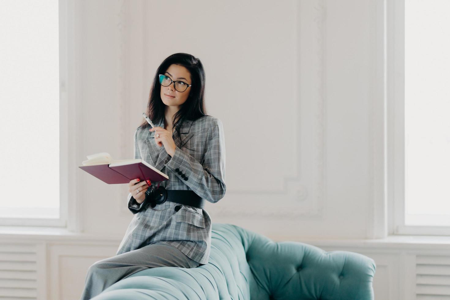 Serious businesswoman dressed in formal wear, concentrated into ... Serious businesswoman dressed in formal wear, concentrated into ...