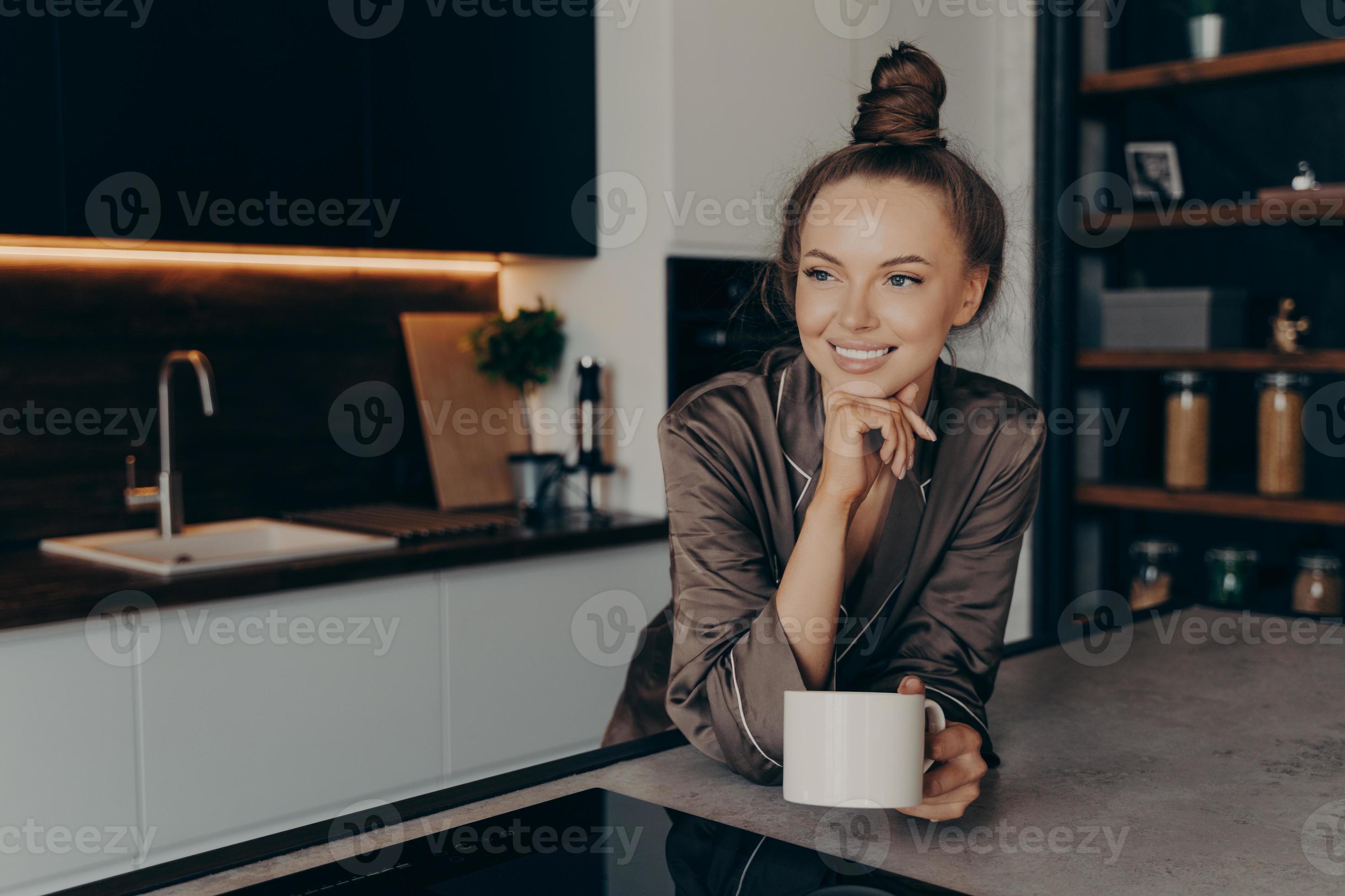 Relaxed Positive Young Woman In Silk Cozy Pajama Having Cup Of Coffee