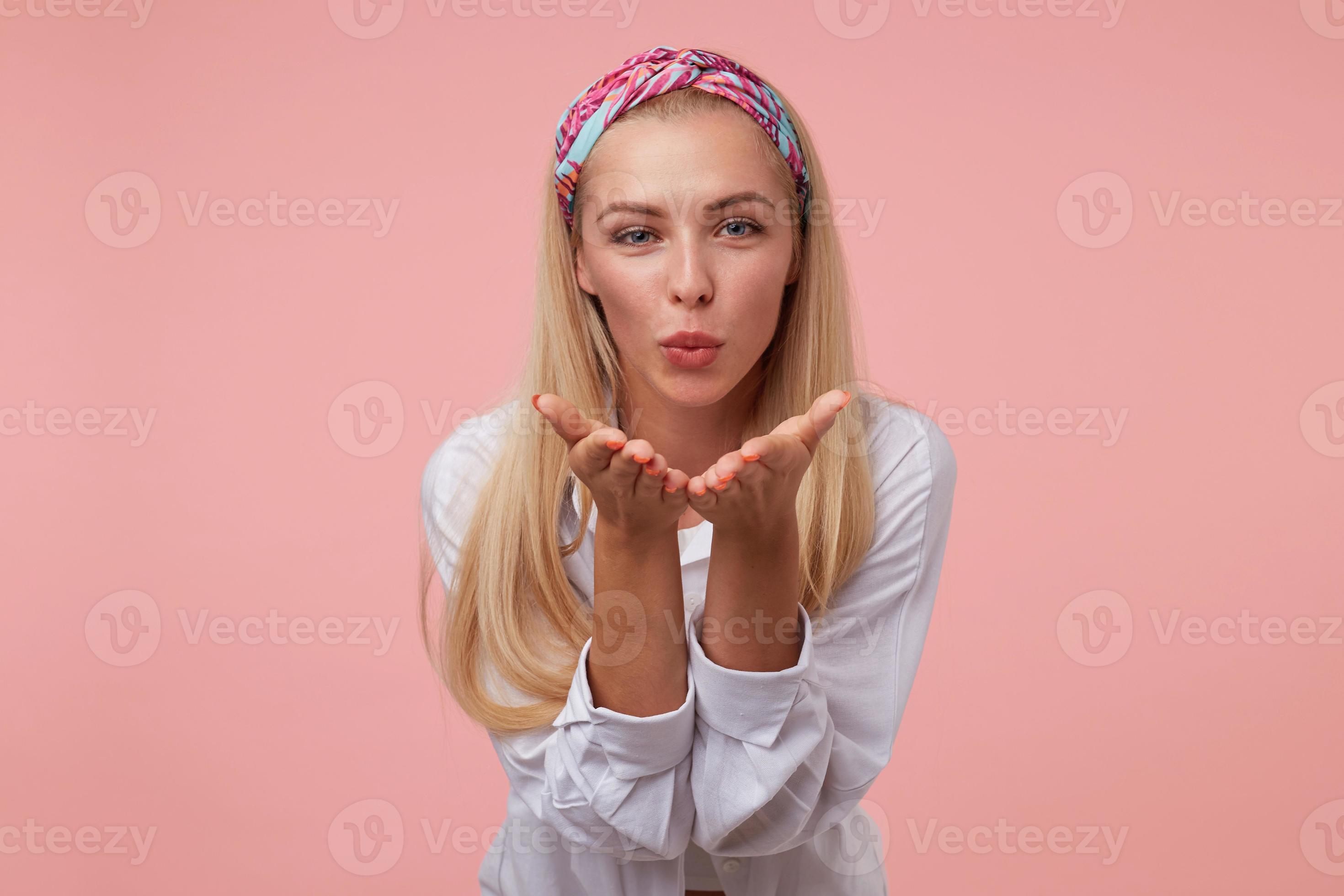 Attractive Woman With Long Blonde Hair Blowing Air Kiss And Looking To Camera Demonstrating Her