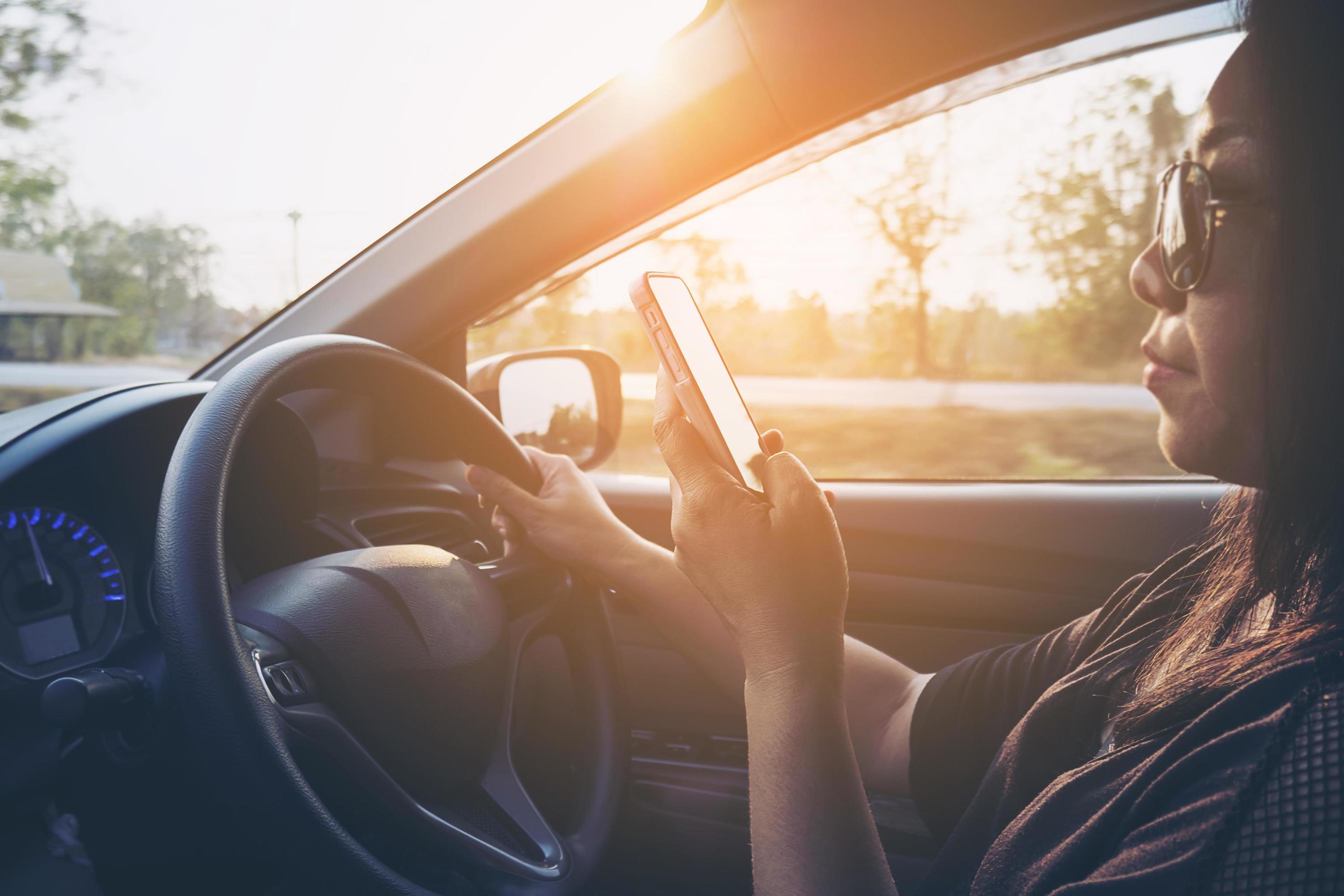 Lady using mobile phone while driving car dangerously 9297529 Stock ...