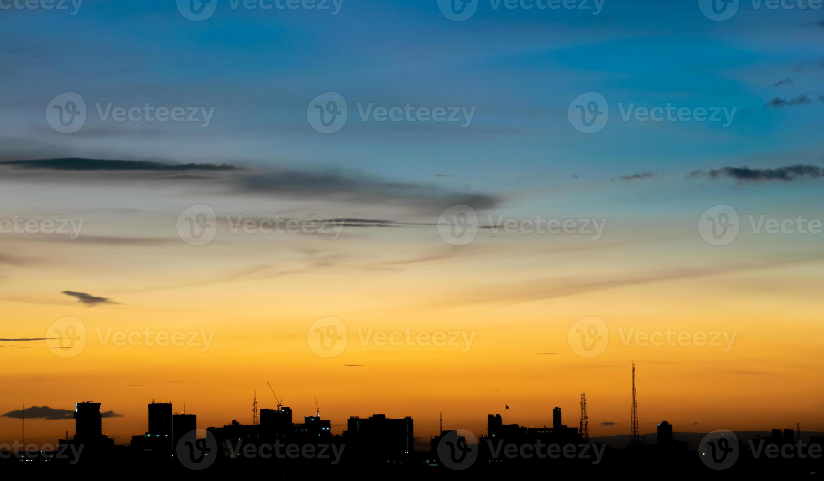 Gives a warm feeling,sunset behind the city building,silhouette city ...