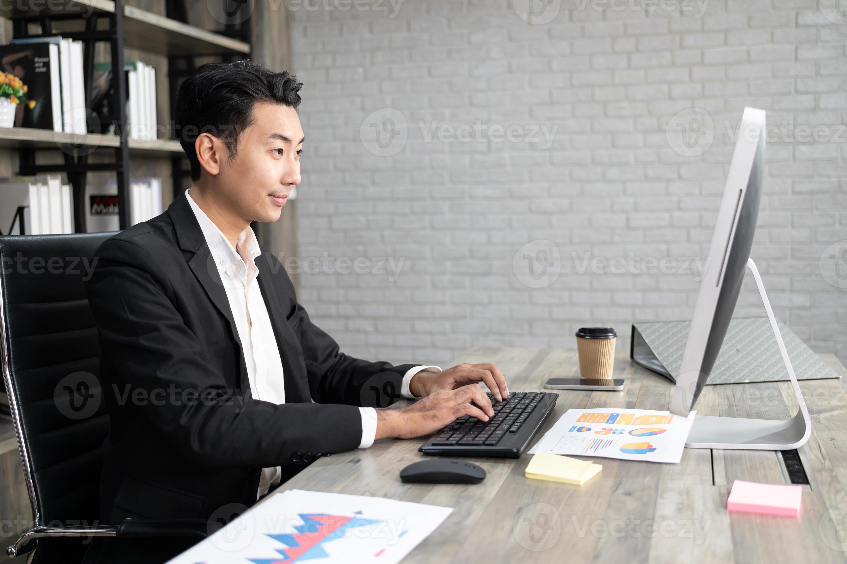 Portrait of business man using computer at workplace in an office ...