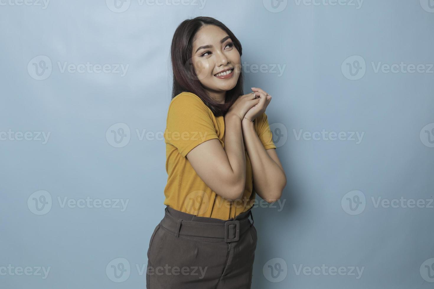 Pleased Asian Woman Reclines On Her Hands And Looking At The Camera Over Blue Background 9854902 5640