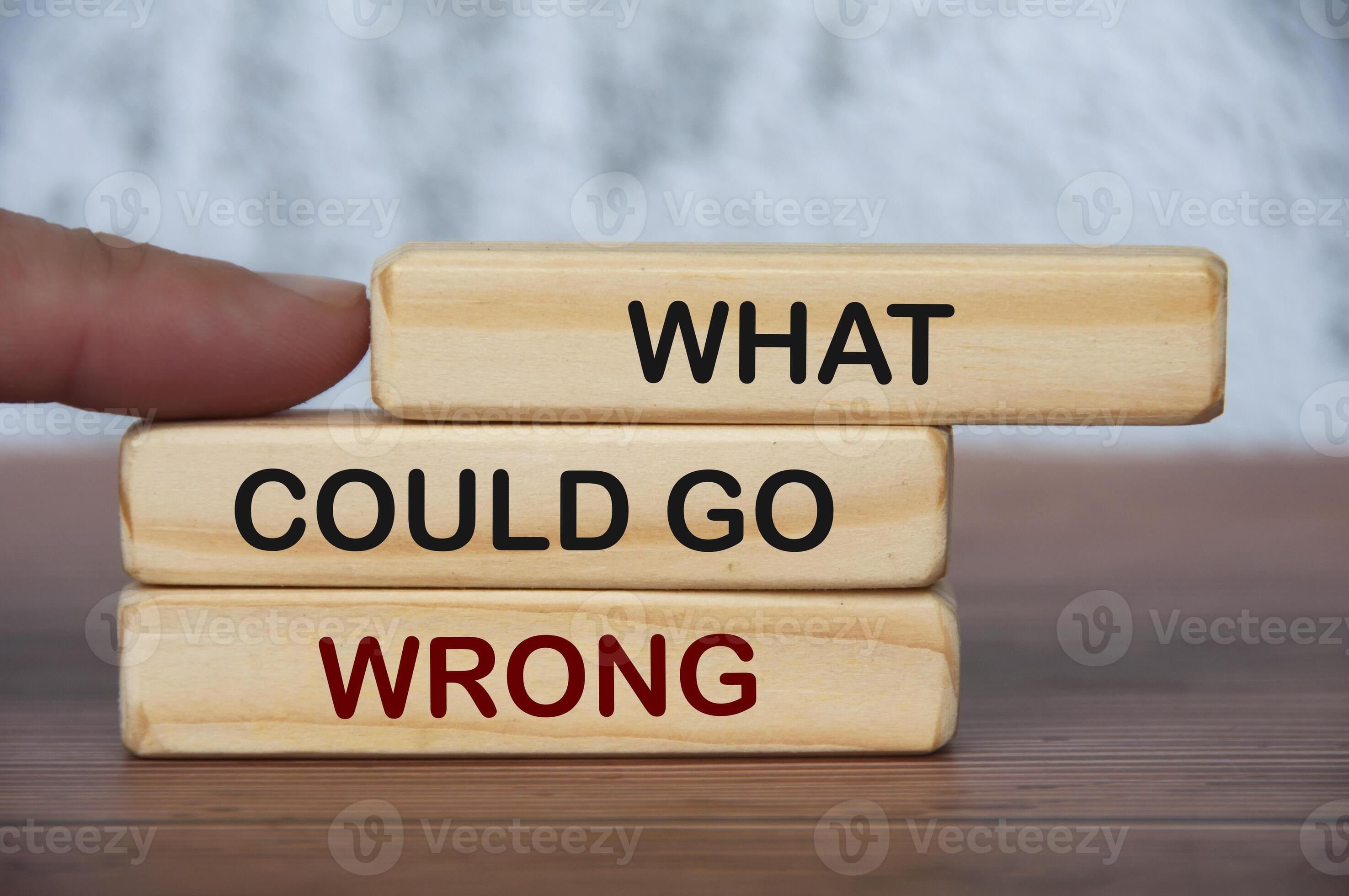 What could go wrong text on wooden blocks with blurred marble ...