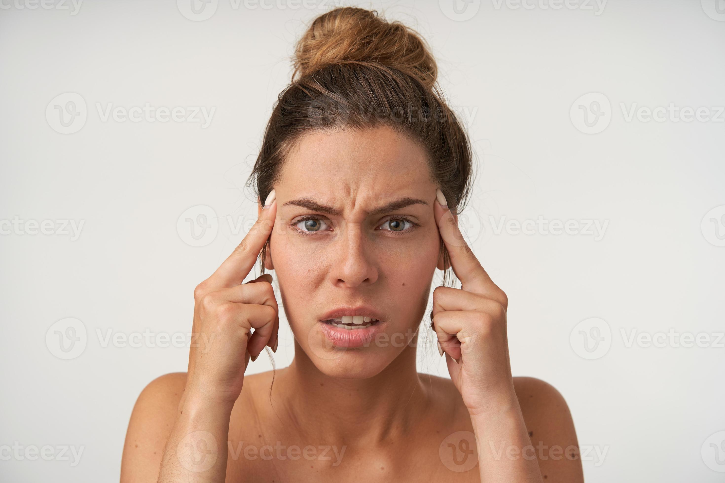 Indoor Shot Of Stressed Young Pretty Woman Posing Over White Background