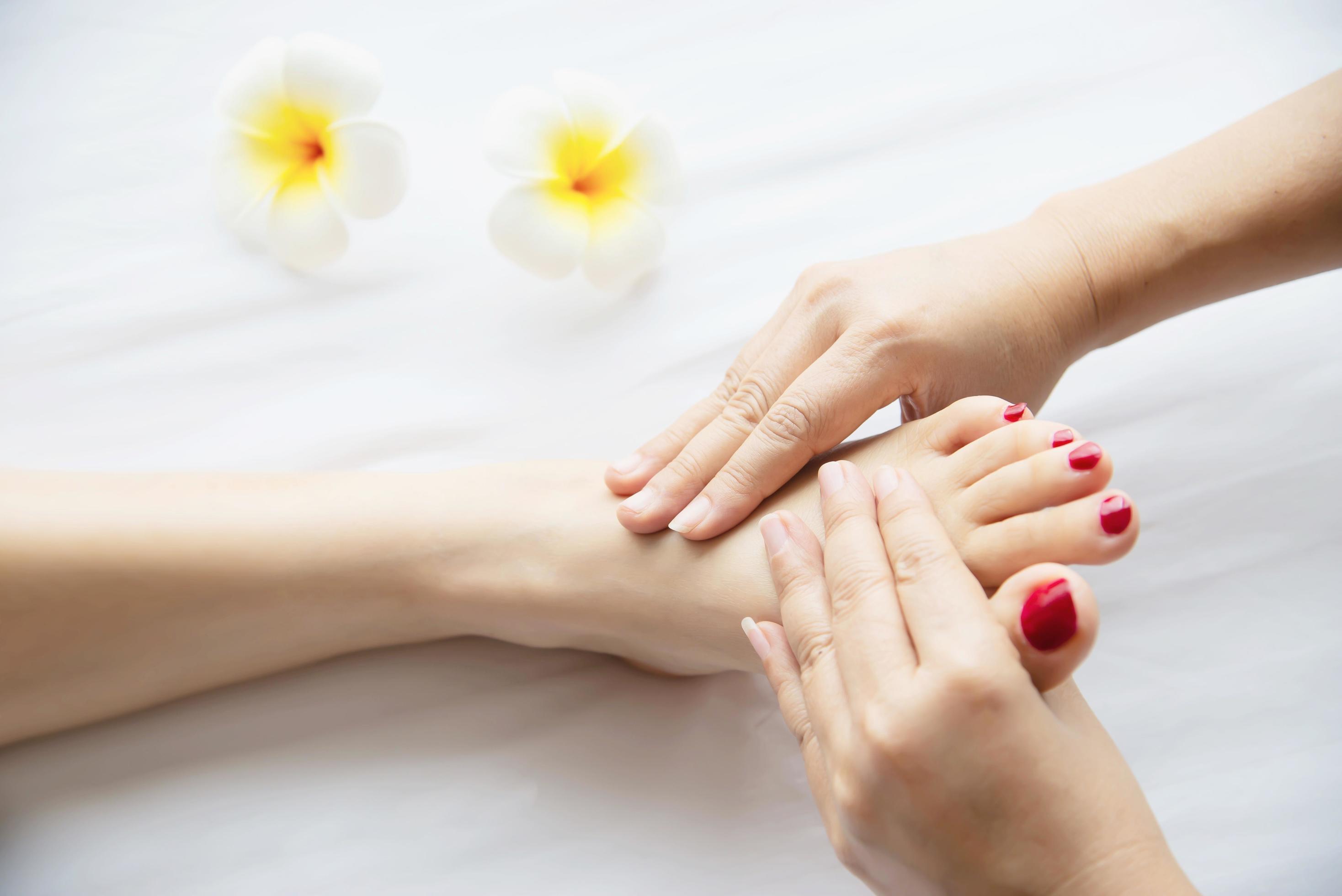 Woman Receiving Foot Massage Service From Masseuse Close Up At Hand And Foot Relax In Foot