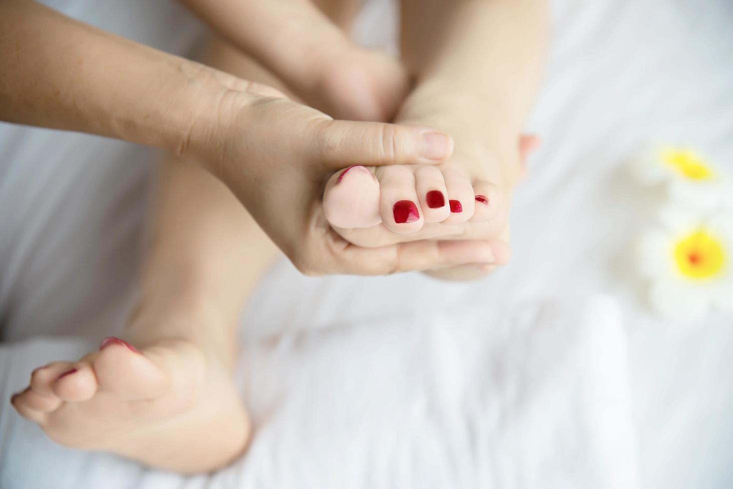 Woman Receiving Foot Massage Service From Masseuse Close Up At Hand And