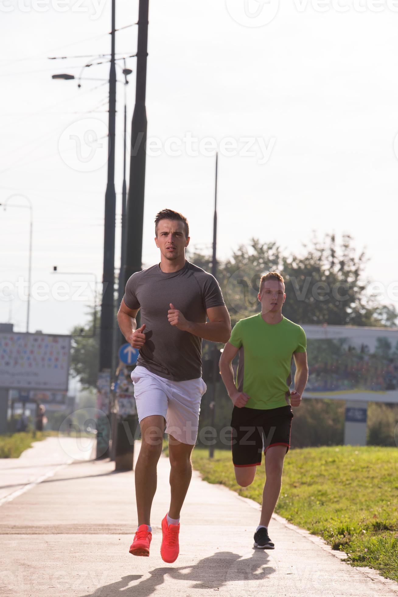Two young men jogging through the city 10428923 Stock Photo at Vecteezy Two young men jogging through the city 10428923 Stock Photo at Vecteezy