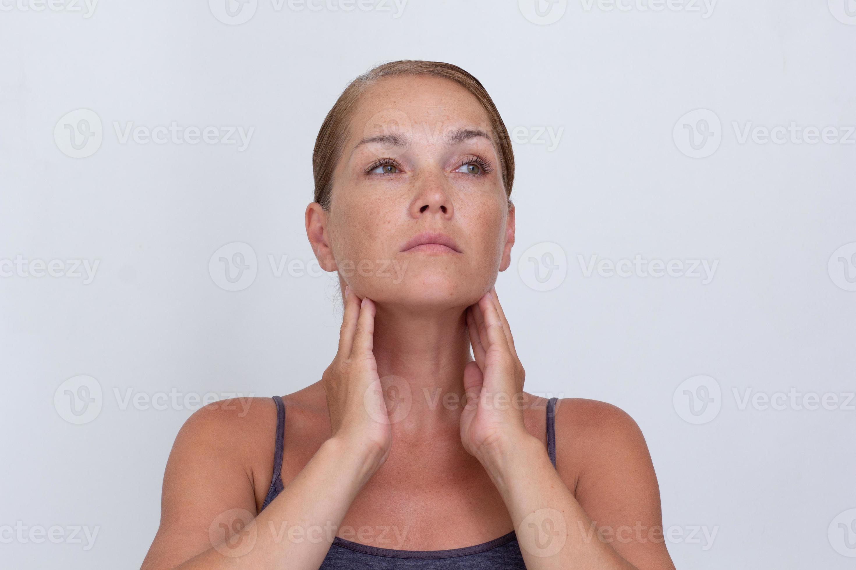 Portrait of woman examining lymph nodes on neckon white background ...