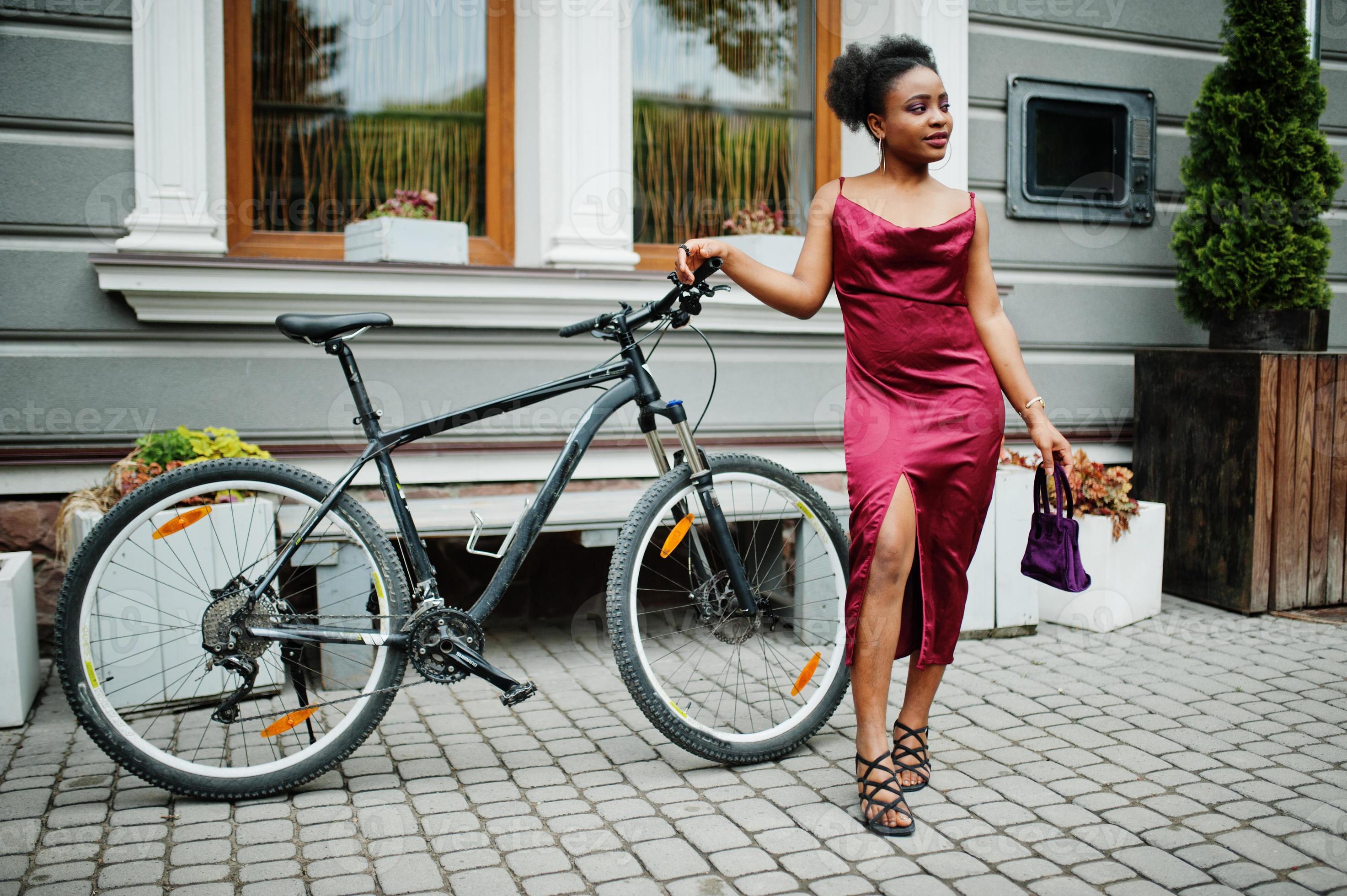 Portrait of a beautiful natural young African woman with afro hair. Black model in red silk ...
