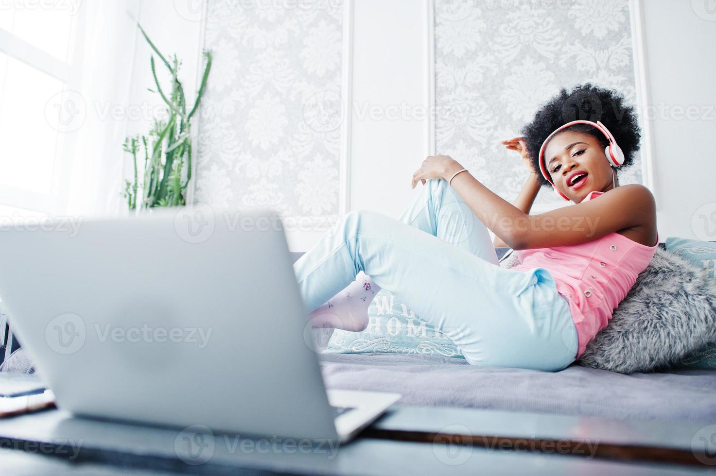 Young African American Woman Sitting On The Couch While Working On
