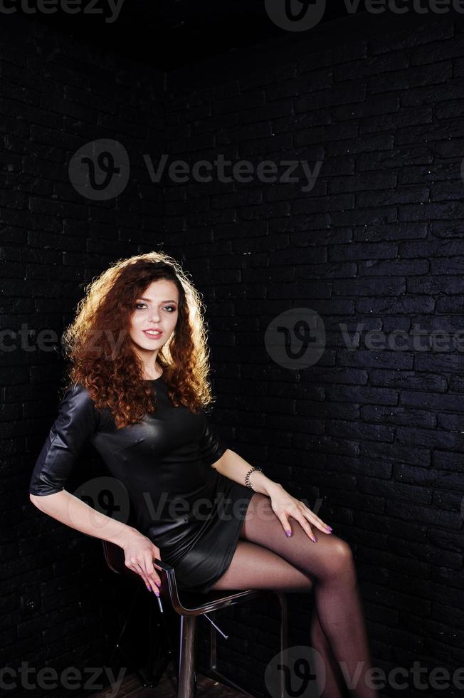 Brunette Curly Haired Long Legs Girl In Black Leather Dress Posed At