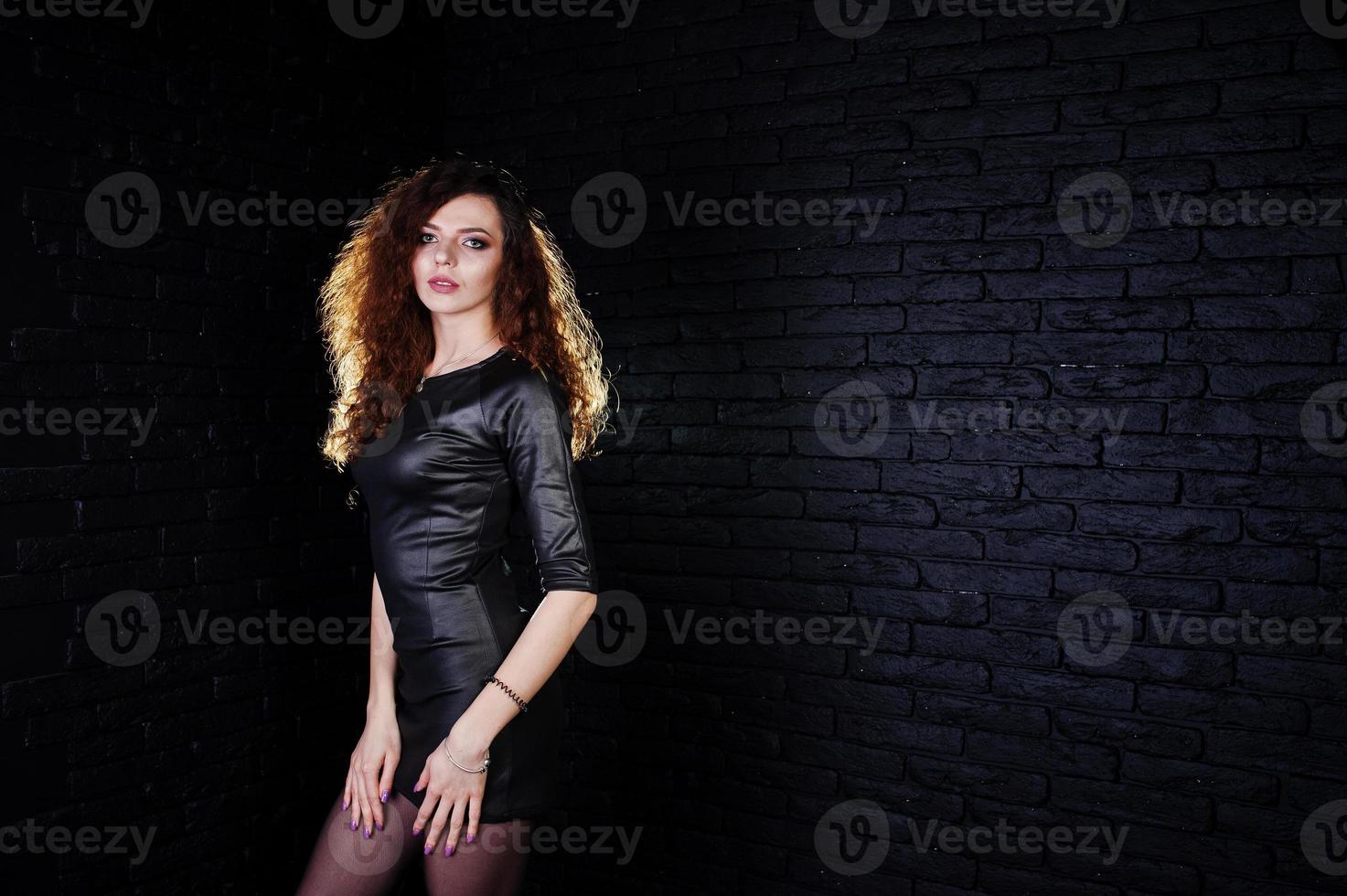 Brunette Curly Haired Long Legs Girl In Black Leather Dress Posed At