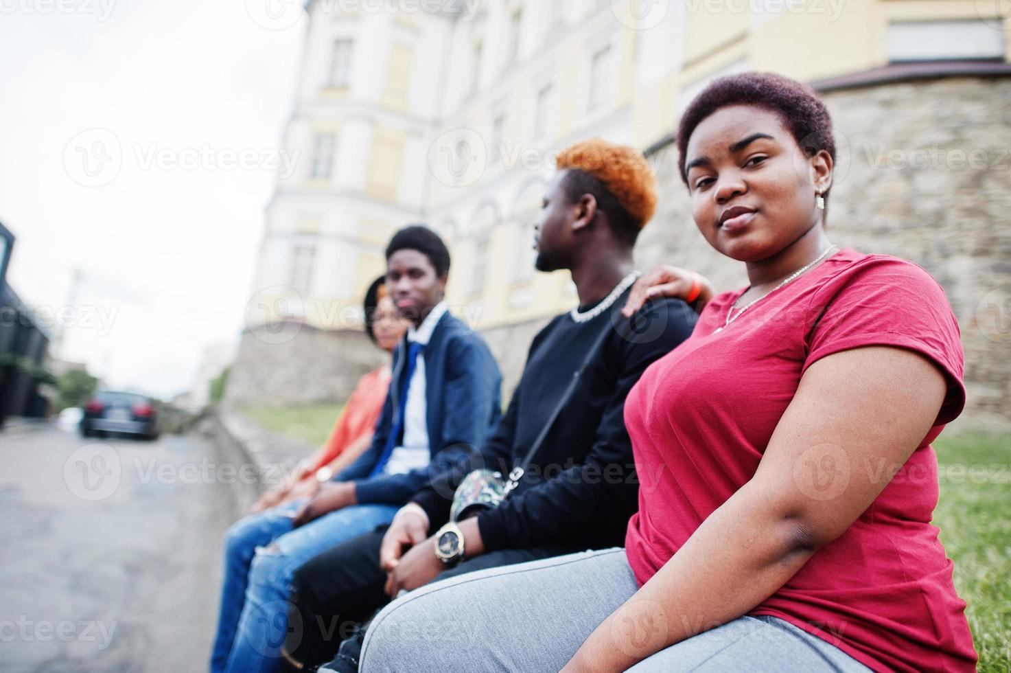 Four African Friends Having Fun Outdoors Two Black Girls With Guys Sit