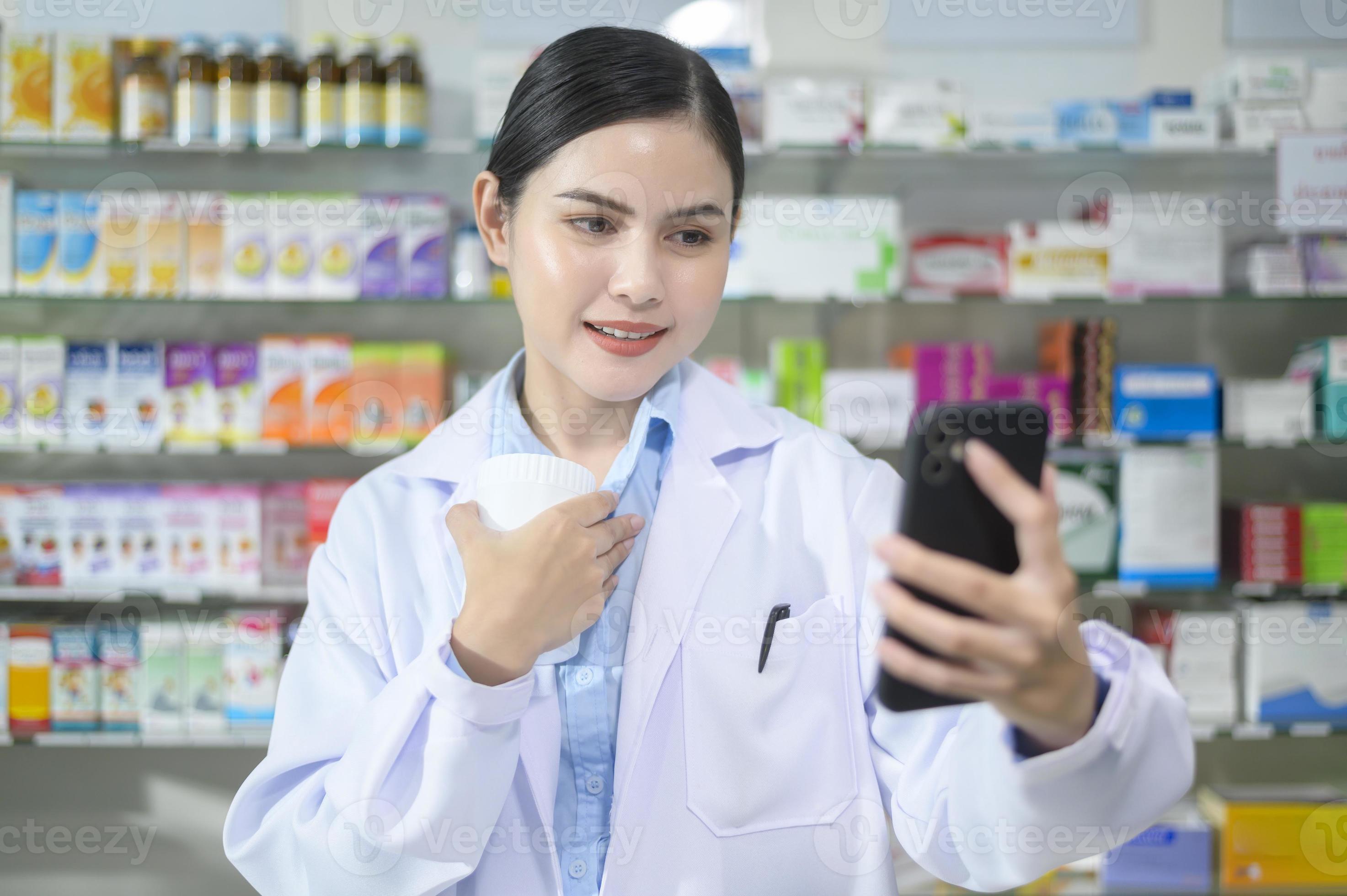 Female pharmacist counseling customer via video call in a modern pharmacy drugstore. 10620564 ...