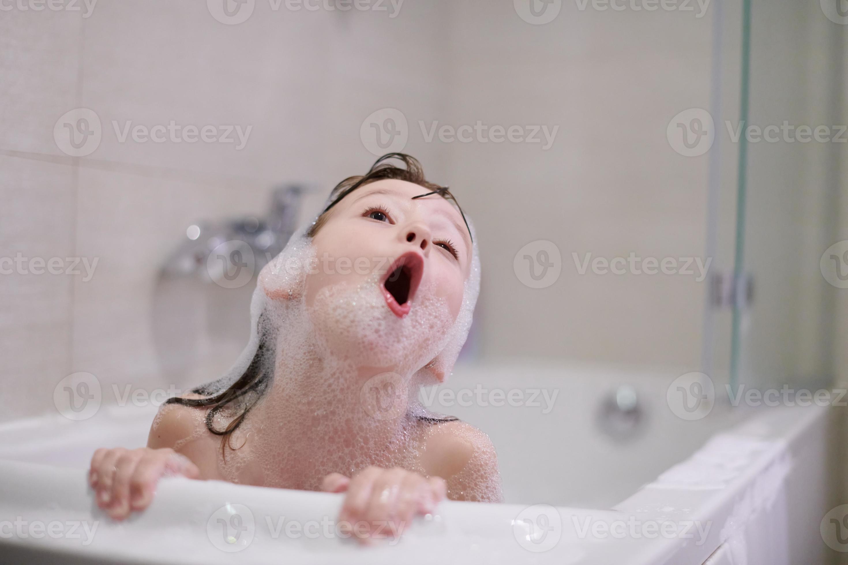 little girl in bath playing with soap foam 10707436 Stock Photo at Vecteezy
