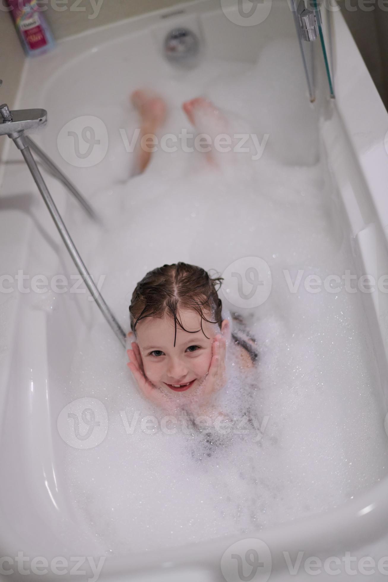 little girl in bath playing with soap foam 10707457 Stock Photo at Vecteezy