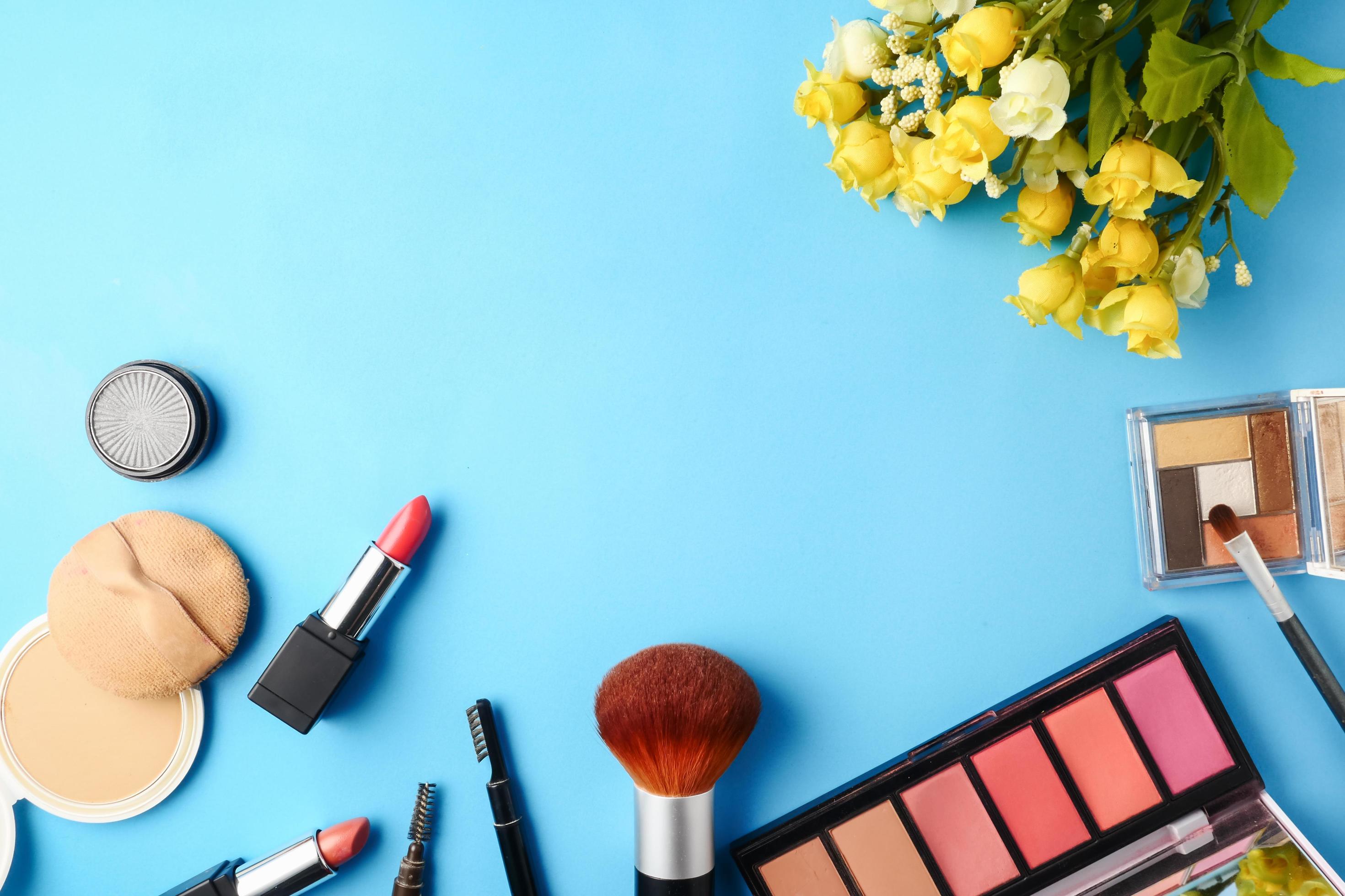 Top view of cosmetics set for makeup on a blue background. Free space for text. 10717840 Stock ...