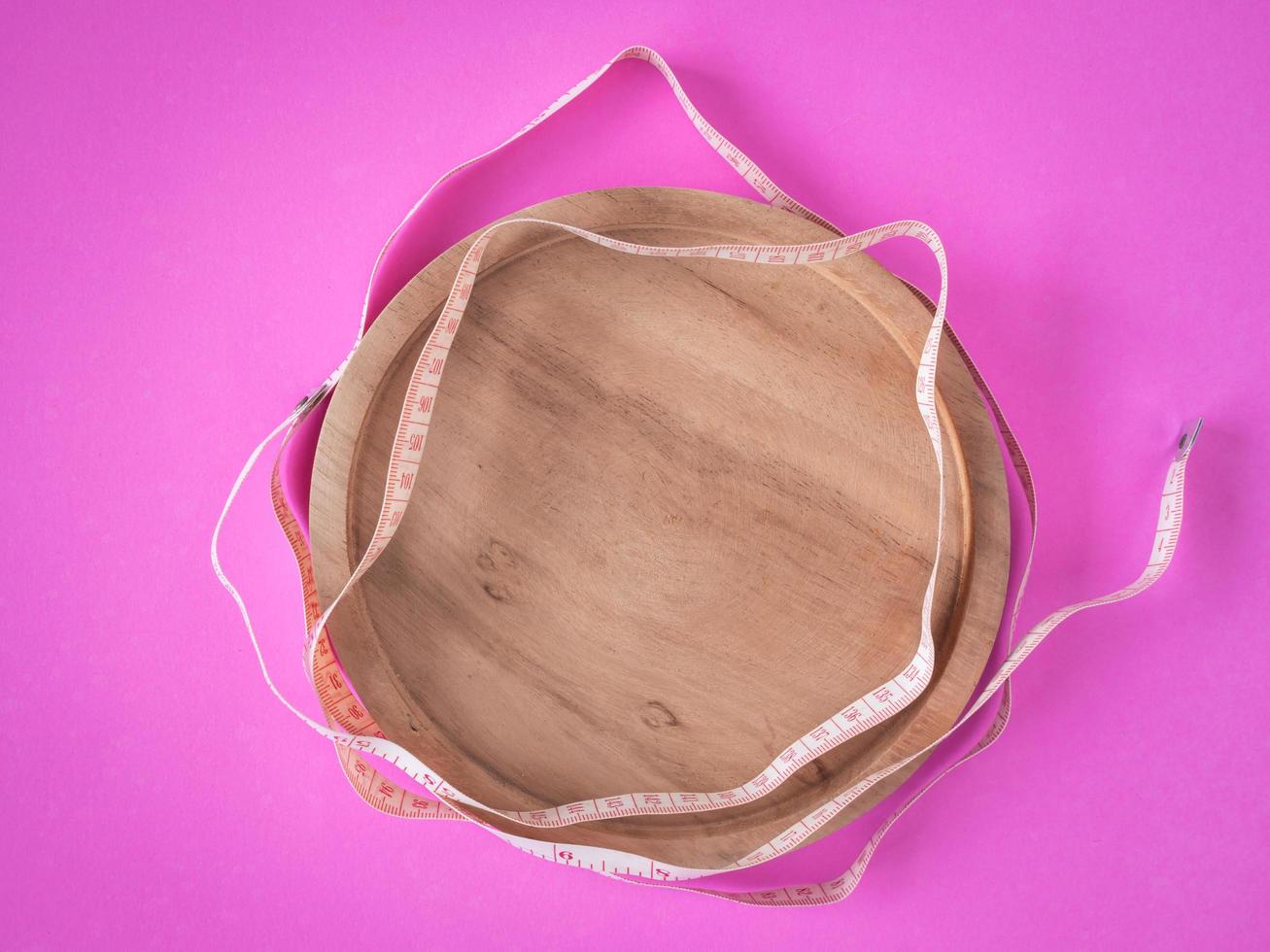 Empty wooden dish with tape measure on pink background. 10718823 Stock ... Empty wooden dish with tape measure on pink background. 10718823 Stock ...