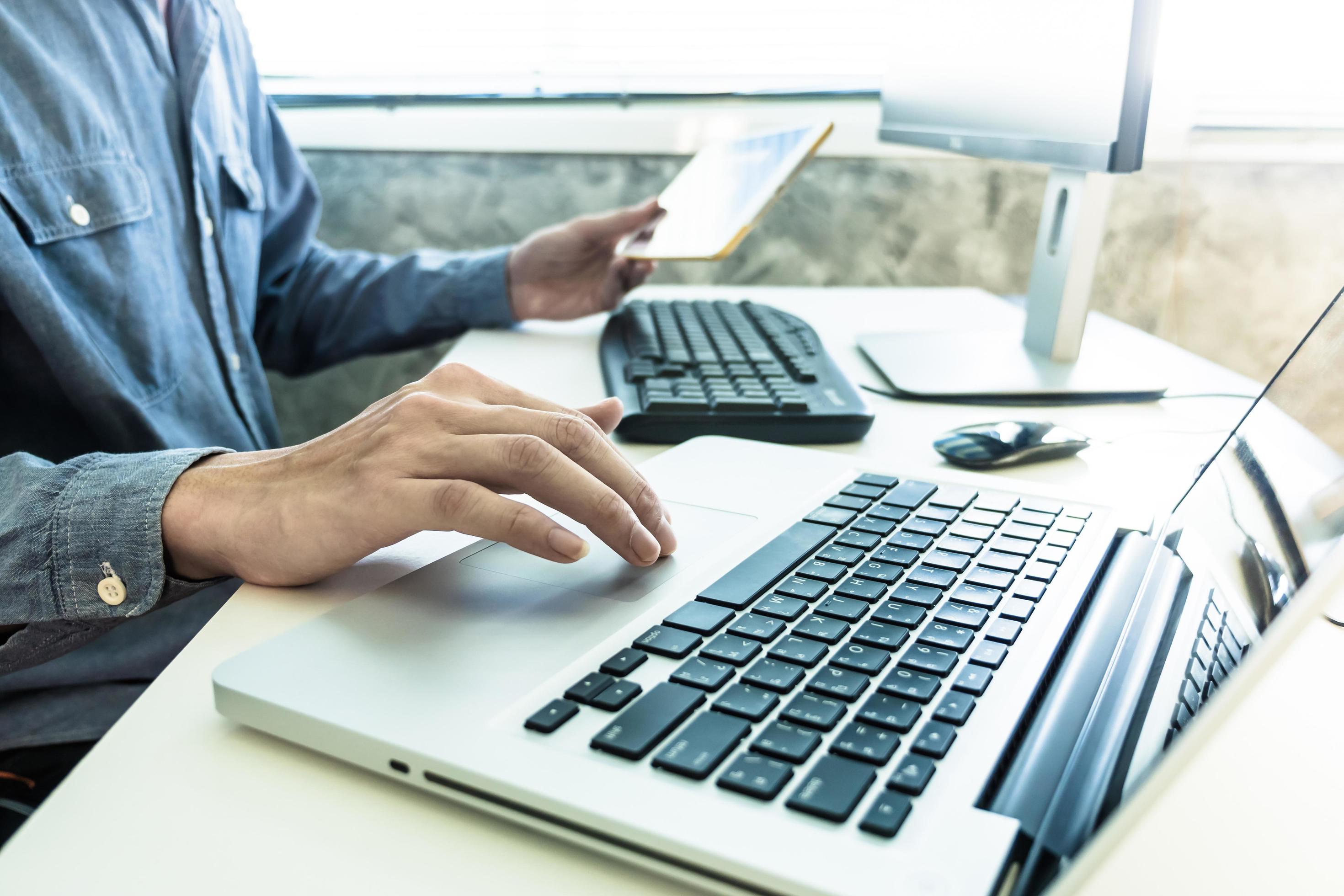 Male hands working on computer and tablet, Software programming web ...