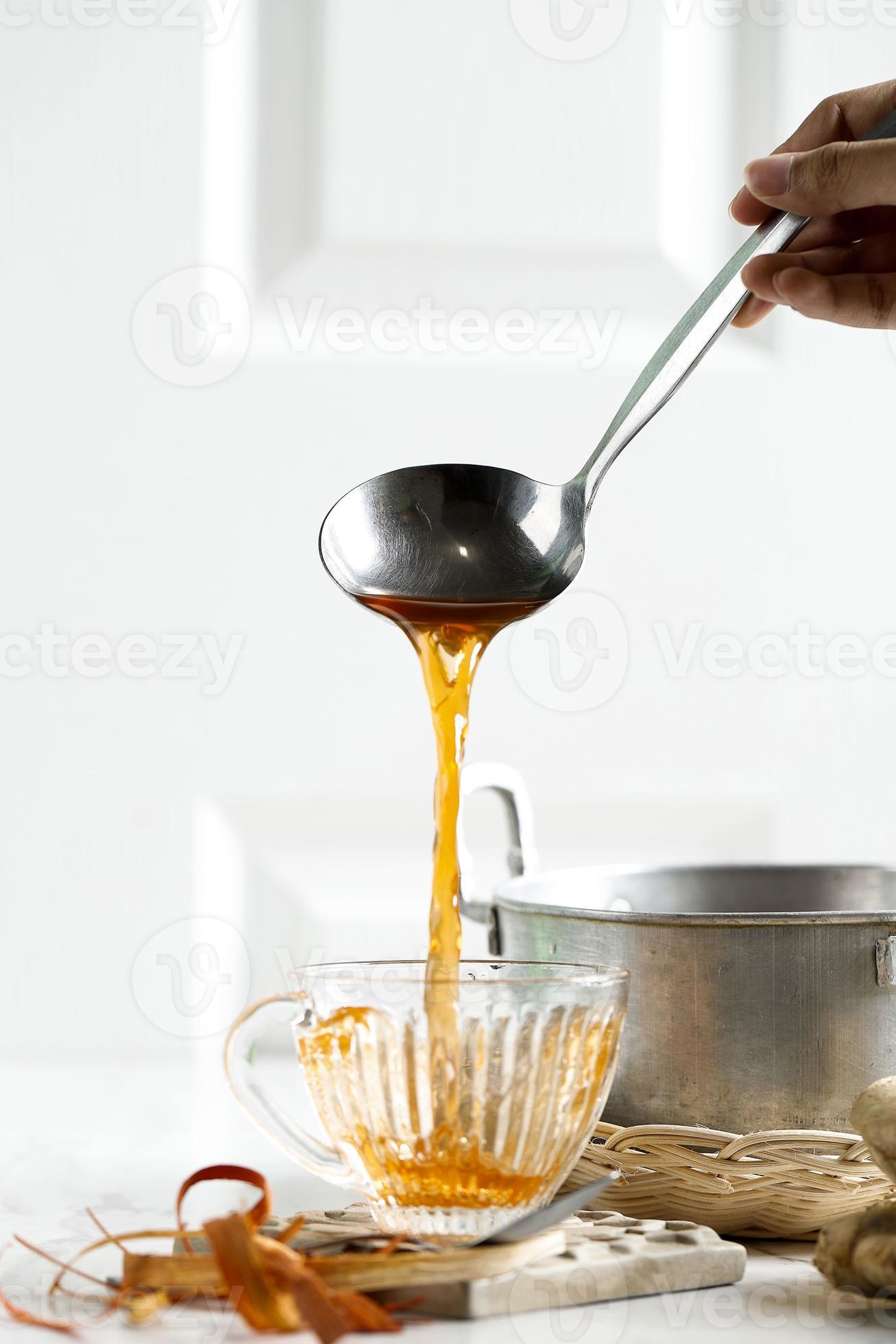 Pouring Wedang Uwuh to the Tea Cup, Red Herbal Tea made from Various Leaf, Wood, and Herbs ...