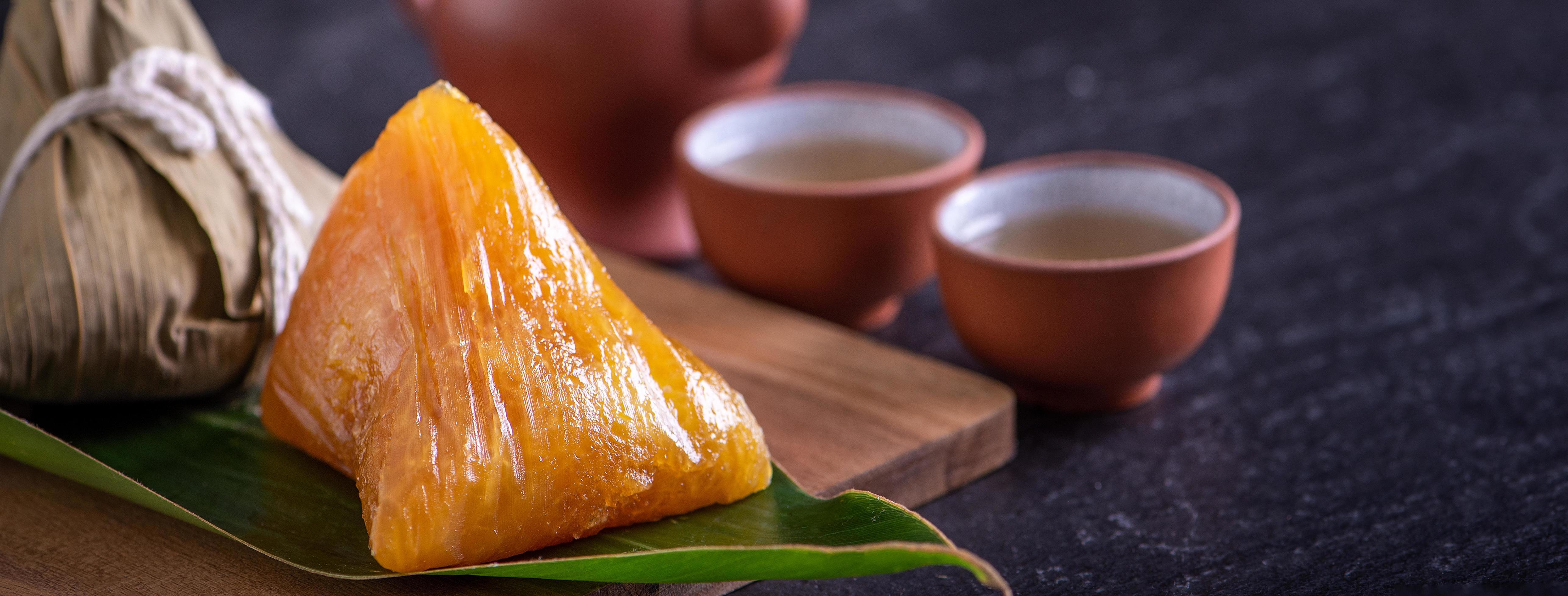 Alkaline rice dumpling zongzi - Traditional sweet Chinese crystal food on a plate to eat for ...