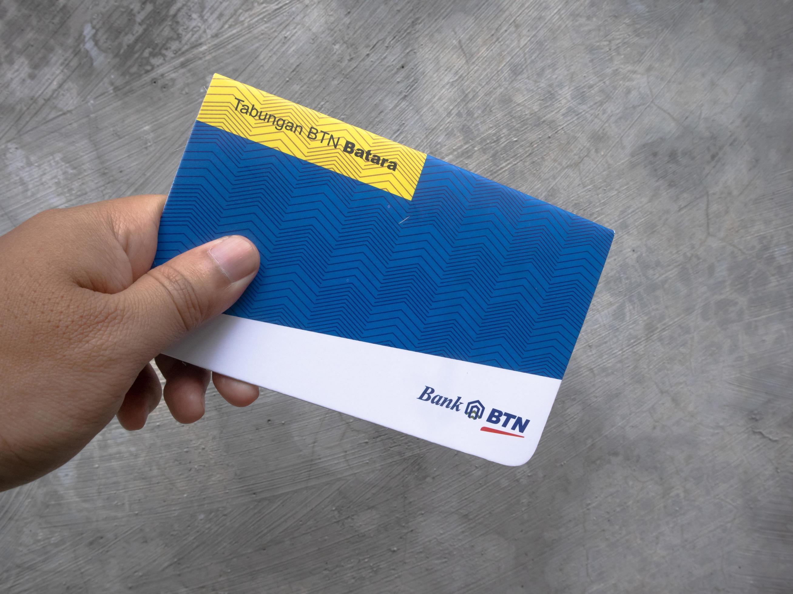 Sidoarjo, Jawa timur, Indonesia, 2022 - a man holding a bank passbook btn 10811408 Stock Photo ...