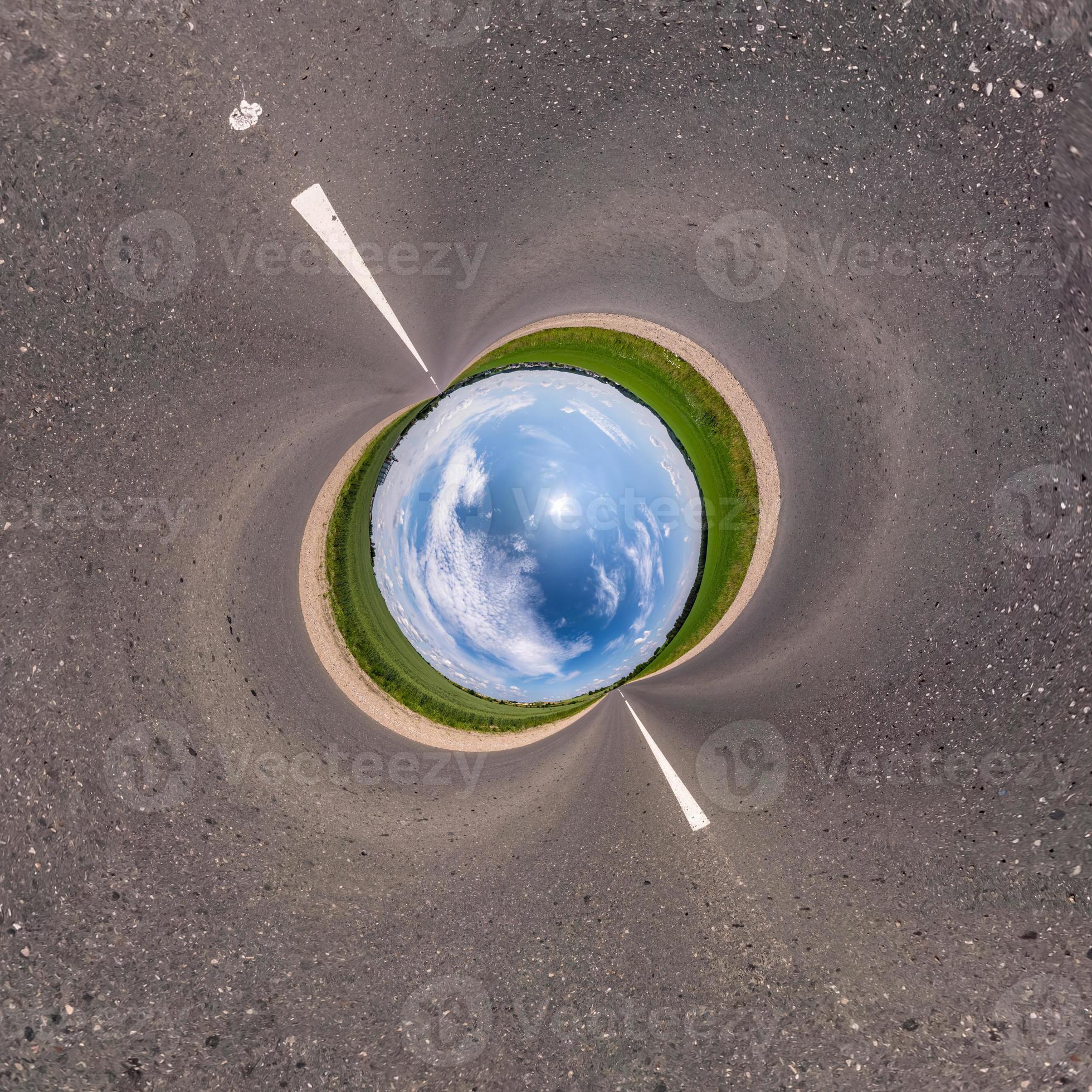 Blue little planet on asphalt road. Inversion of tiny planet ...
