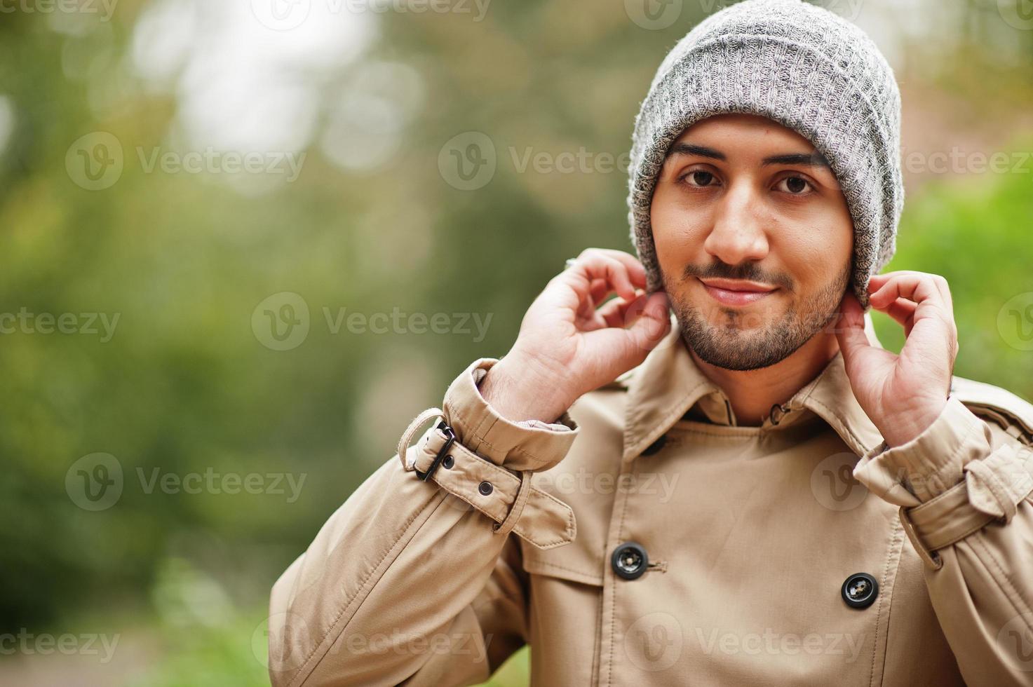 Stylish kuwaiti man at trench coat and hat. 10988726 Stock Photo at Vecteezy