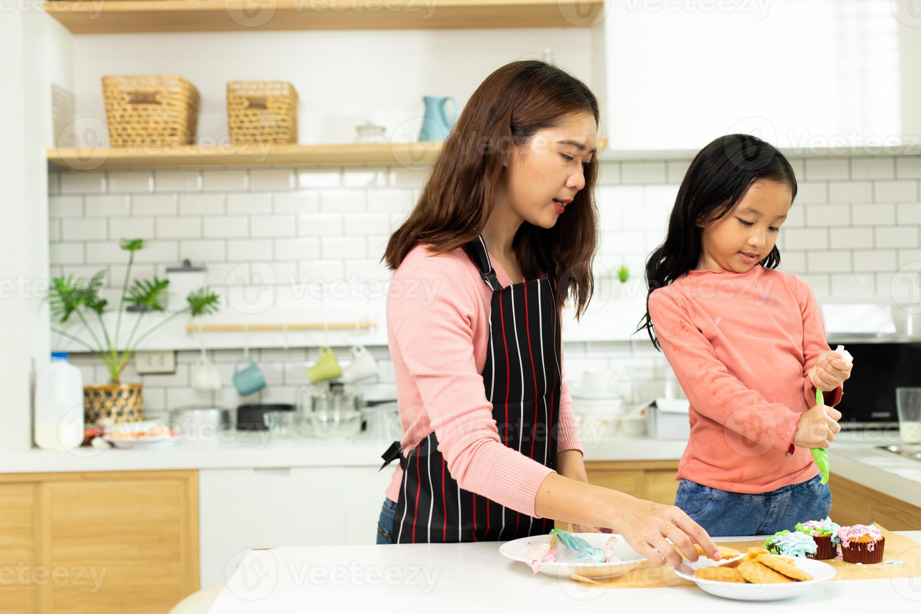 Asian Preschool kid person make Cake cooking in kitchen, Mother prepare decoration pretty with ...