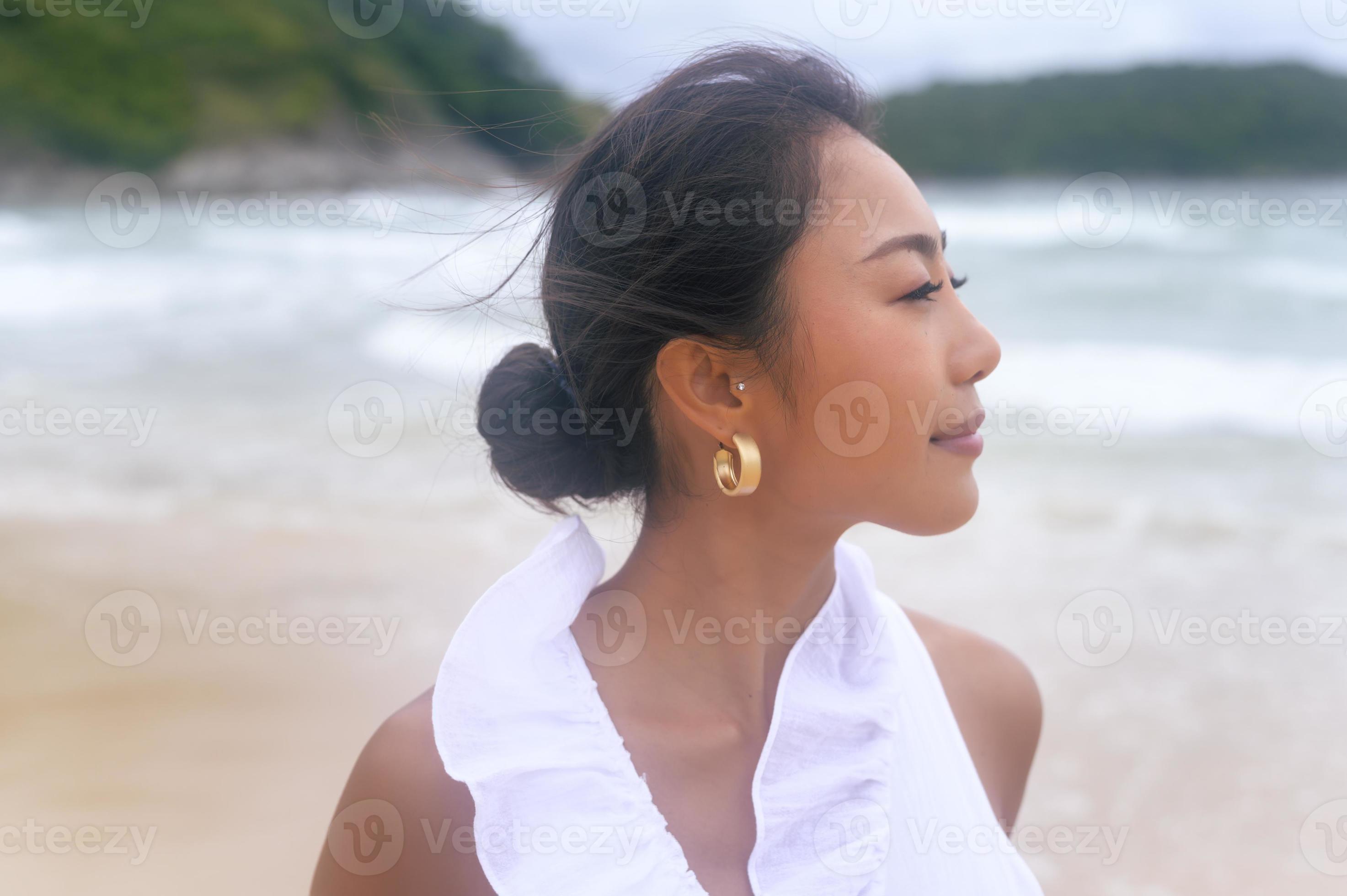 Beautiful Young Woman Wearing White Dress On The Beach On Holidays
