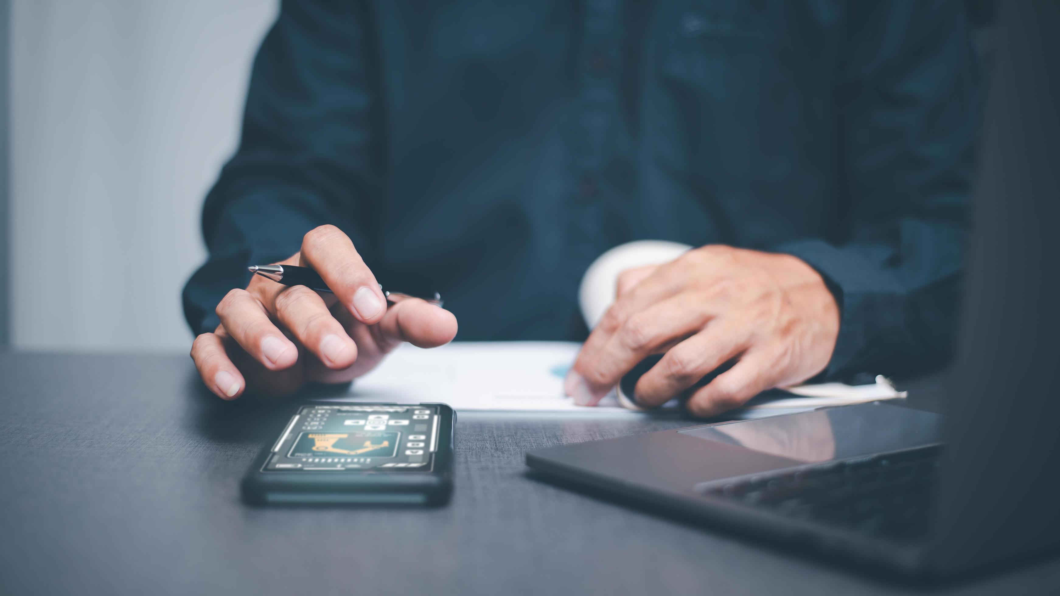 Engineer inspects robot's automated robotic arm Via a smartphone ...