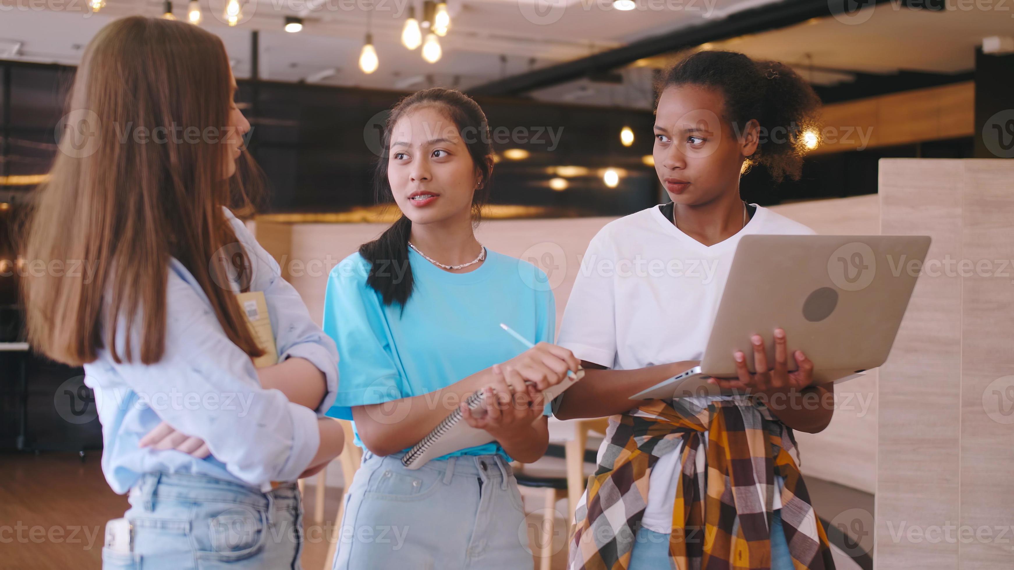 A group of friends discussing homework in a coffee shop. Multiethnic ... A group of friends discussing homework in a coffee shop. Multiethnic ...