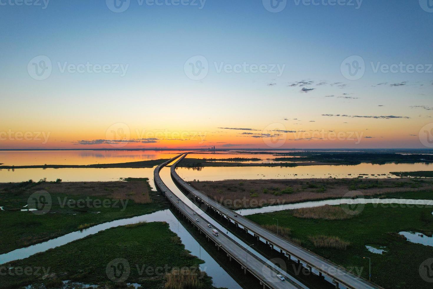 Aerial view of Mobile Bay and Jubilee Parkway bridge at sunset on the Alabama Gulf Coast ...