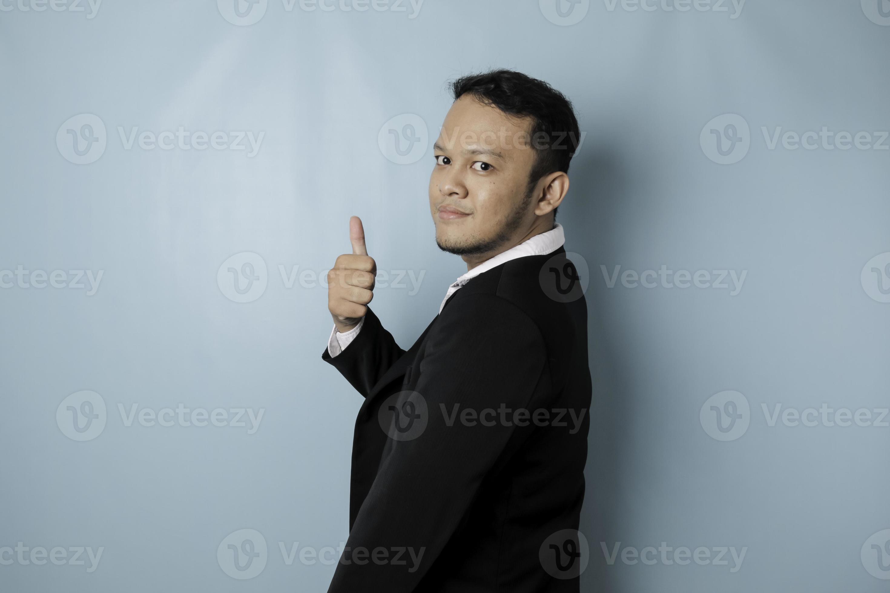 Excited Asian businessman wearing suit gives thumbs up hand gesture of ...