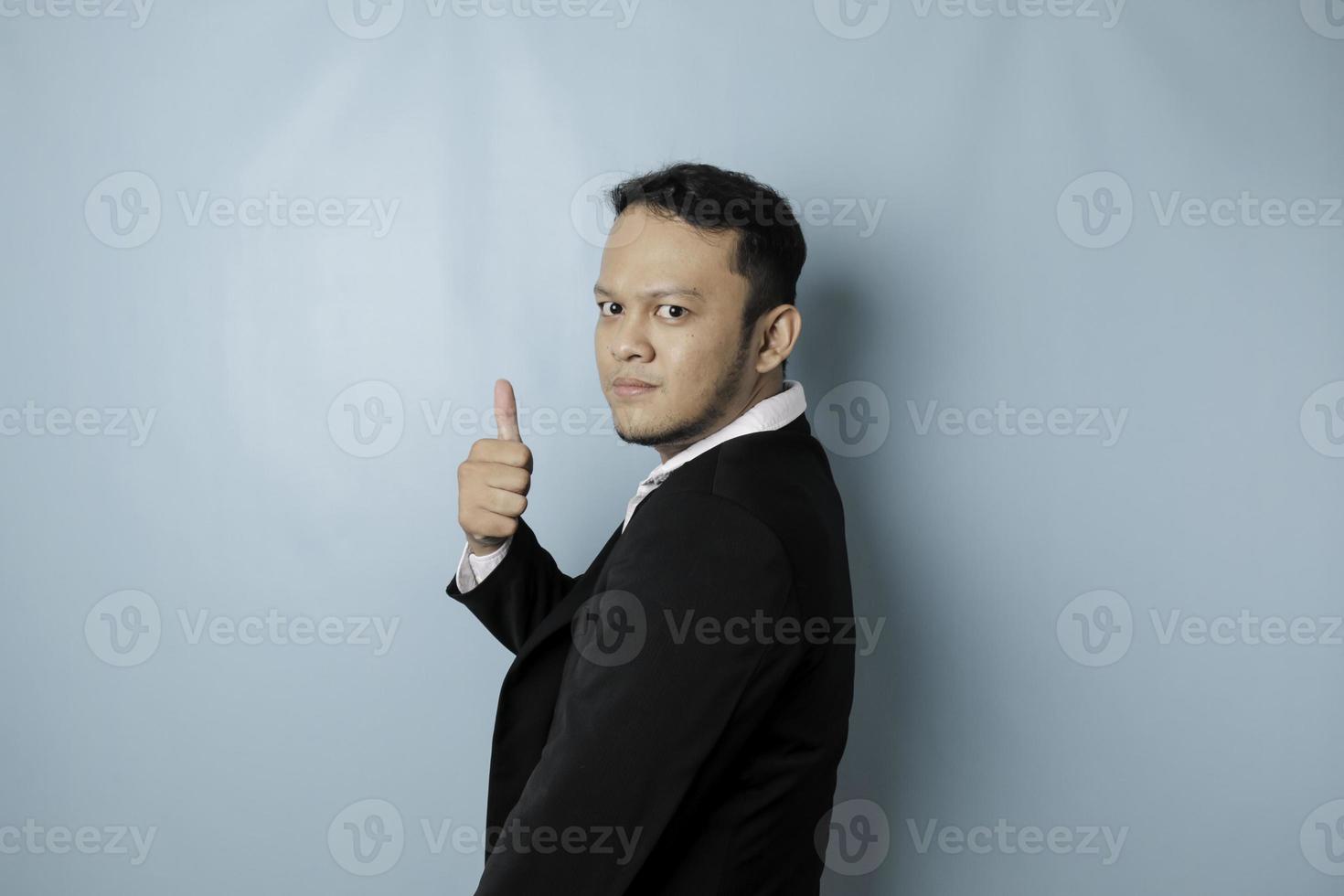 Excited Asian businessman wearing suit gives thumbs up hand gesture of ...