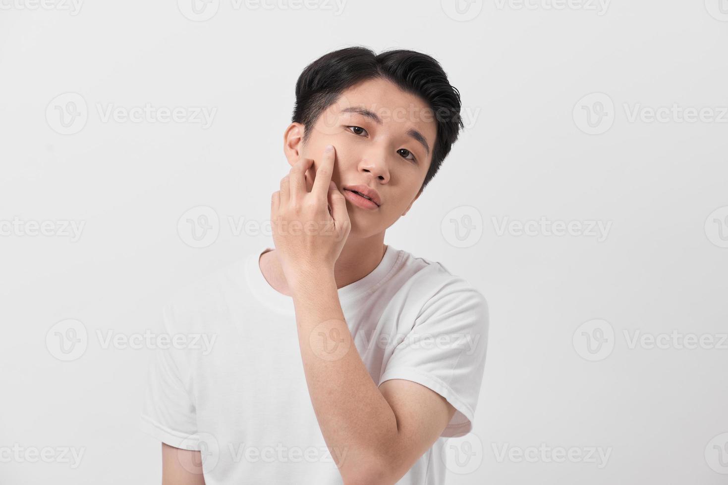 Young man touching his face, 11138341 Stock Photo at Vecteezy Young man touching his face, 11138341 Stock Photo at Vecteezy