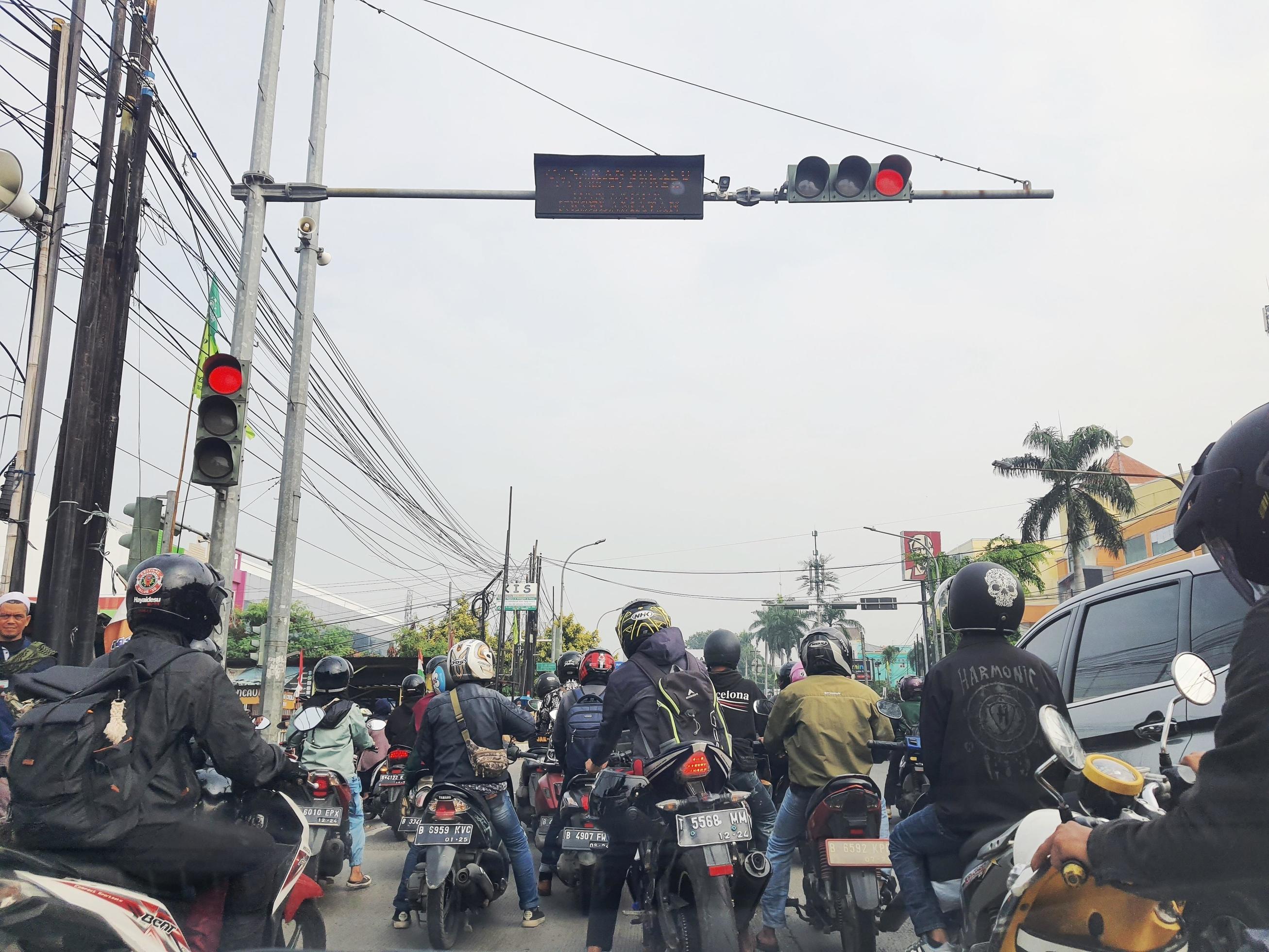 West Java, Indonesia on July 2022. Many motorcyclists are stopping at ...