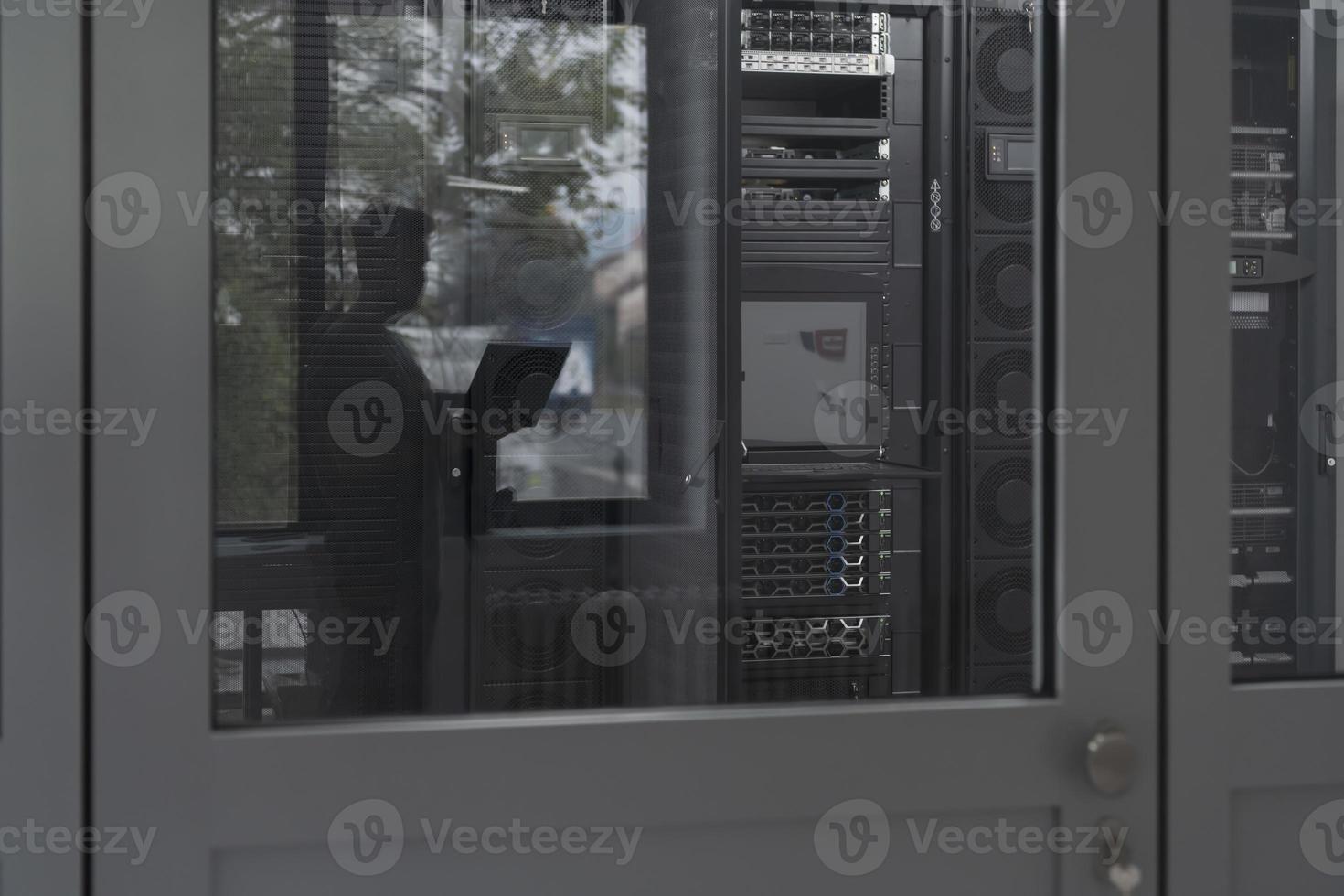 Software Engineer Working On A Laptop Computer In A Modern Server Room