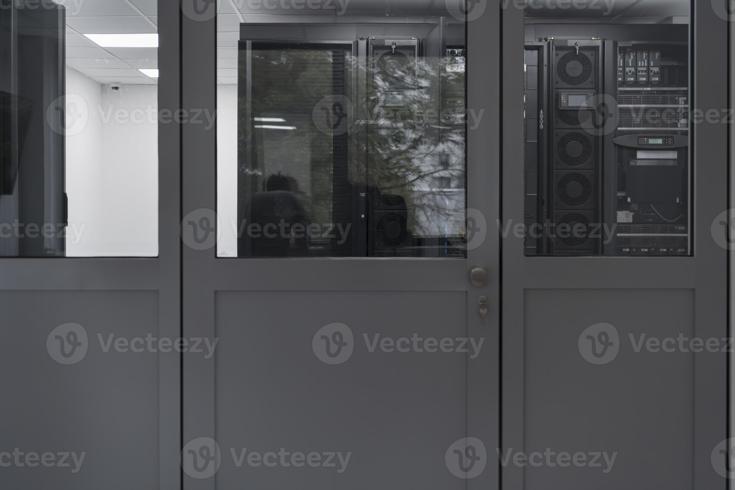 Software Engineer Working On A Laptop Computer In A Modern Server Room