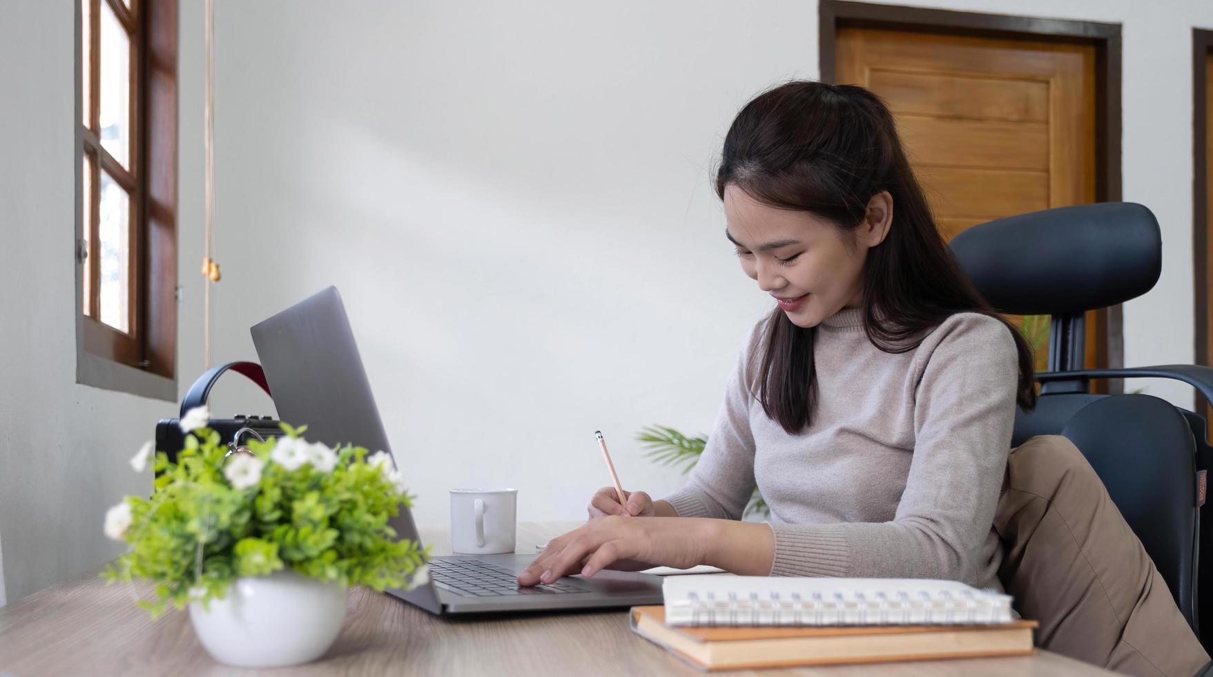 Beautiful woman writing taking notes while sitting in front her ...
