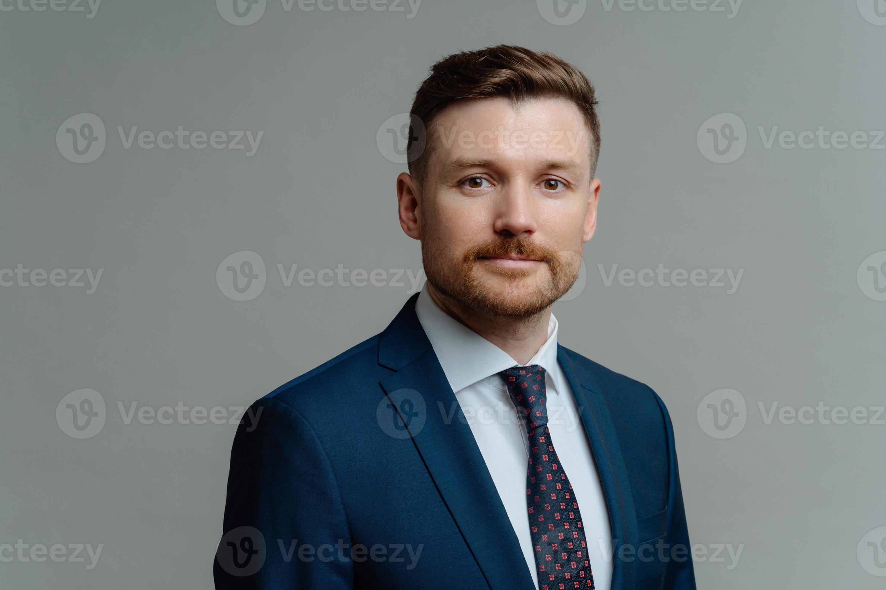 Handsome unshaven man in suit posing against grey background 11278055 ...