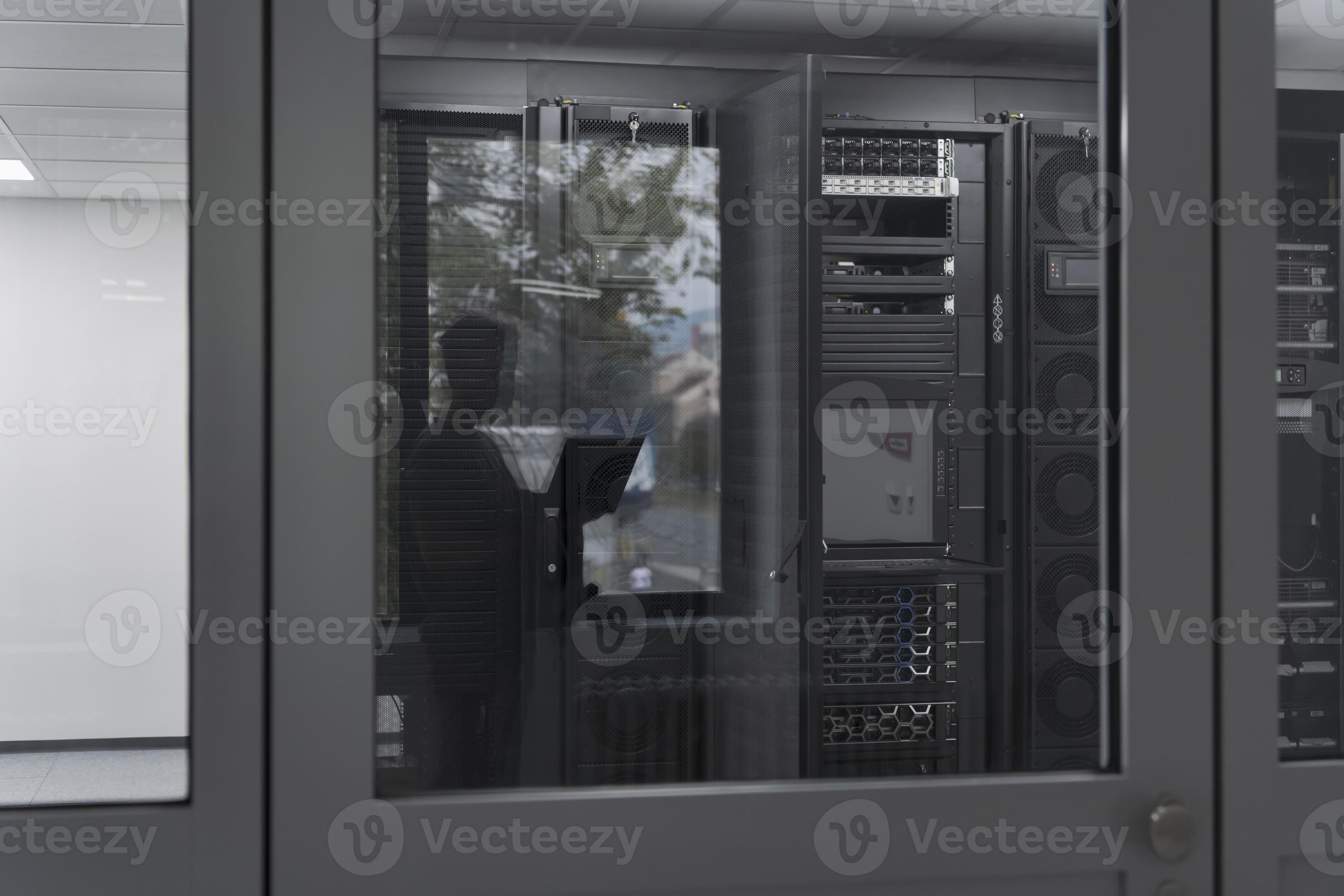 Software Engineer Working On A Laptop Computer In A Modern Server Room