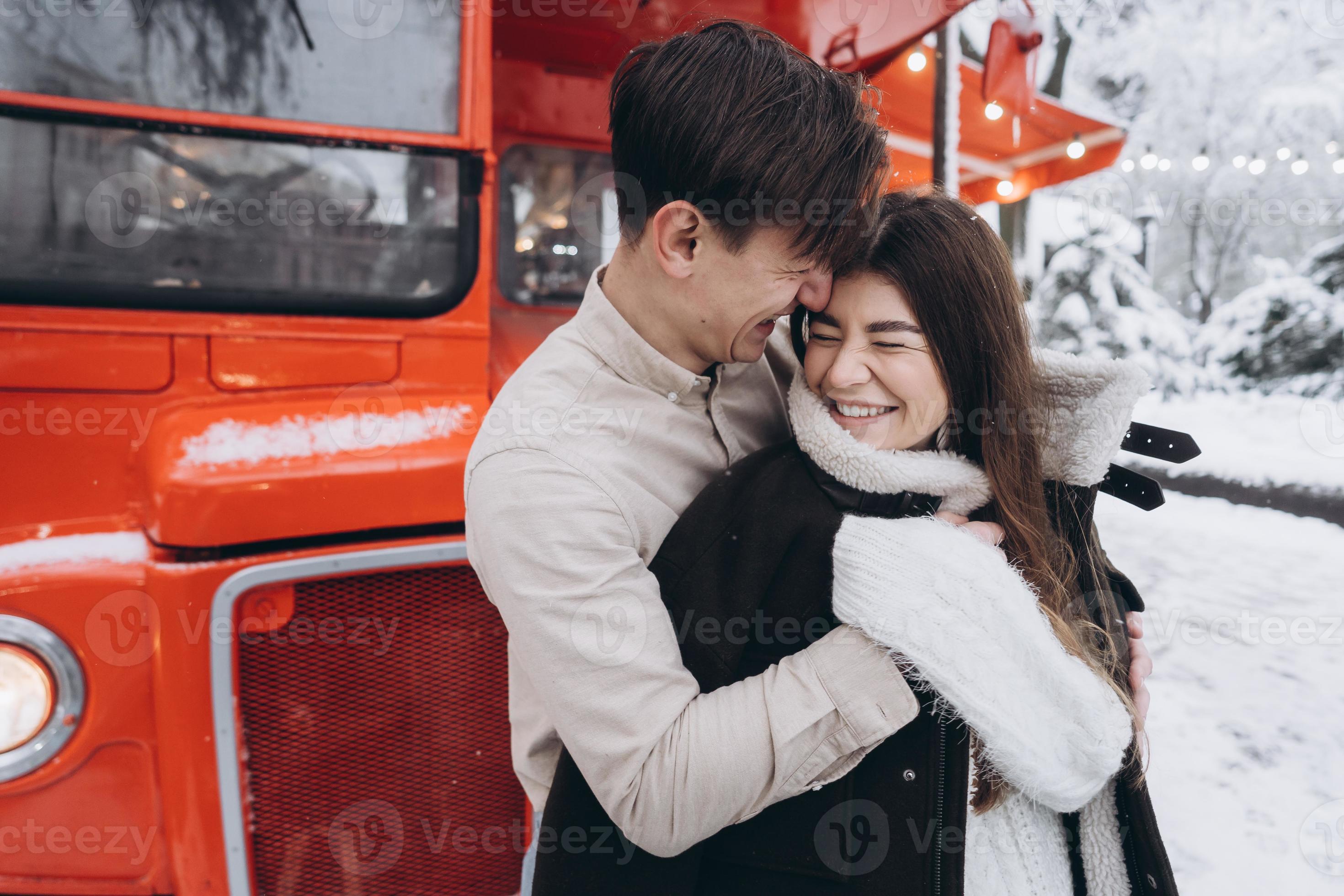 young guy warms his beautiful girl with jacket on a snowy street 11434086 Stock Photo at Vecteezy