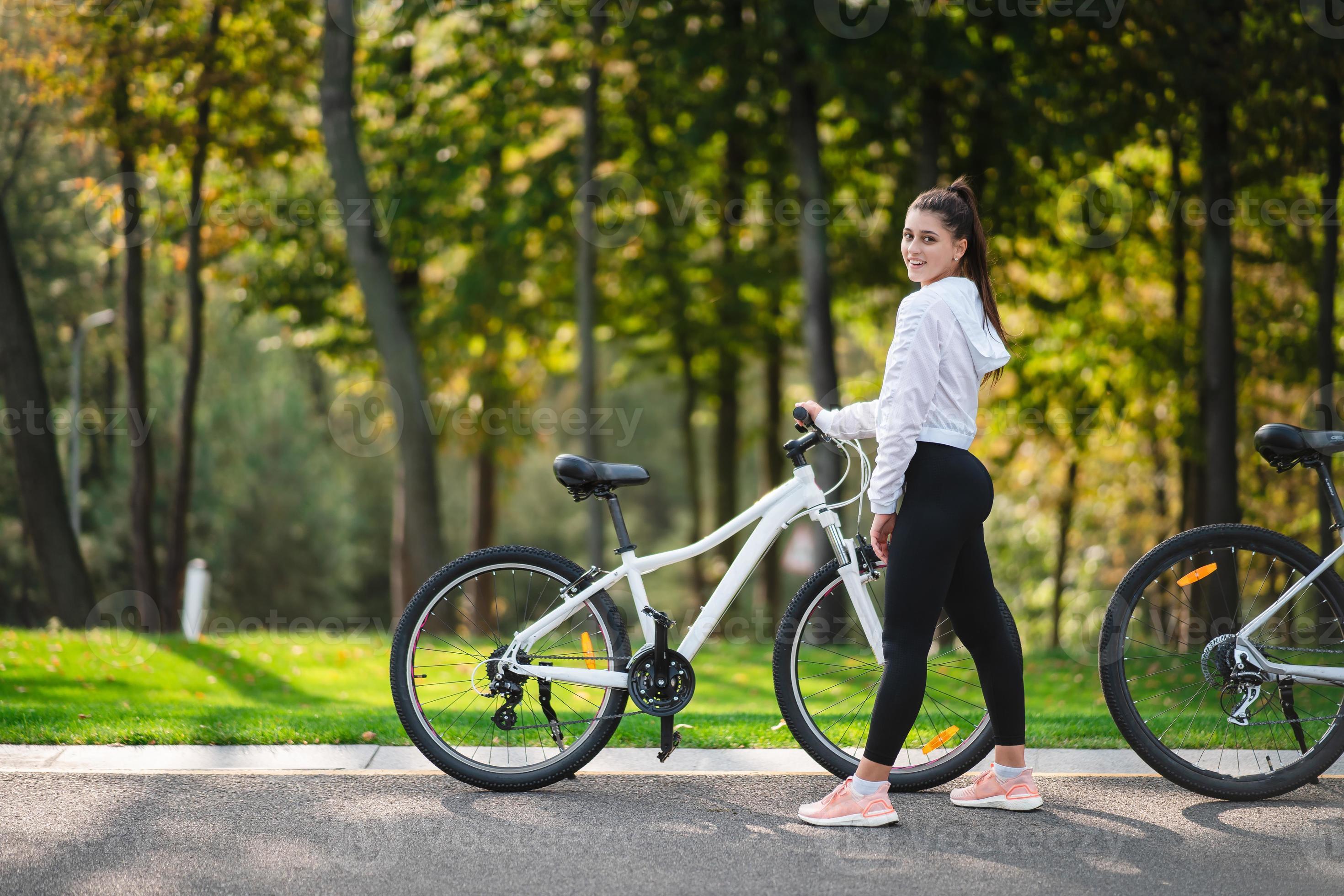 Beautiful girl posing at white bicycle. Walk in nature. 11443081 Stock Photo at Vecteezy